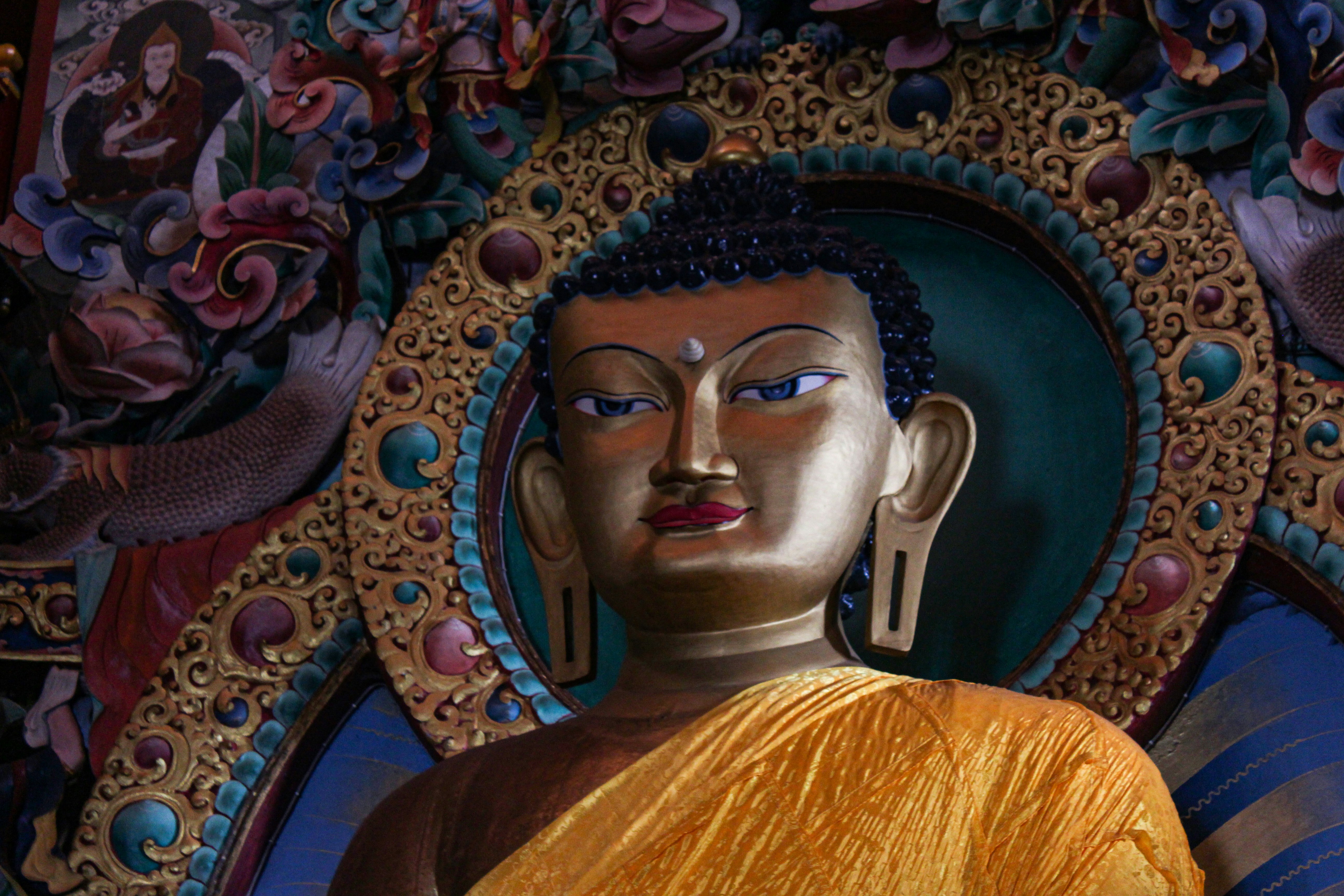 Golden Buddha Beneath Ornate Auras