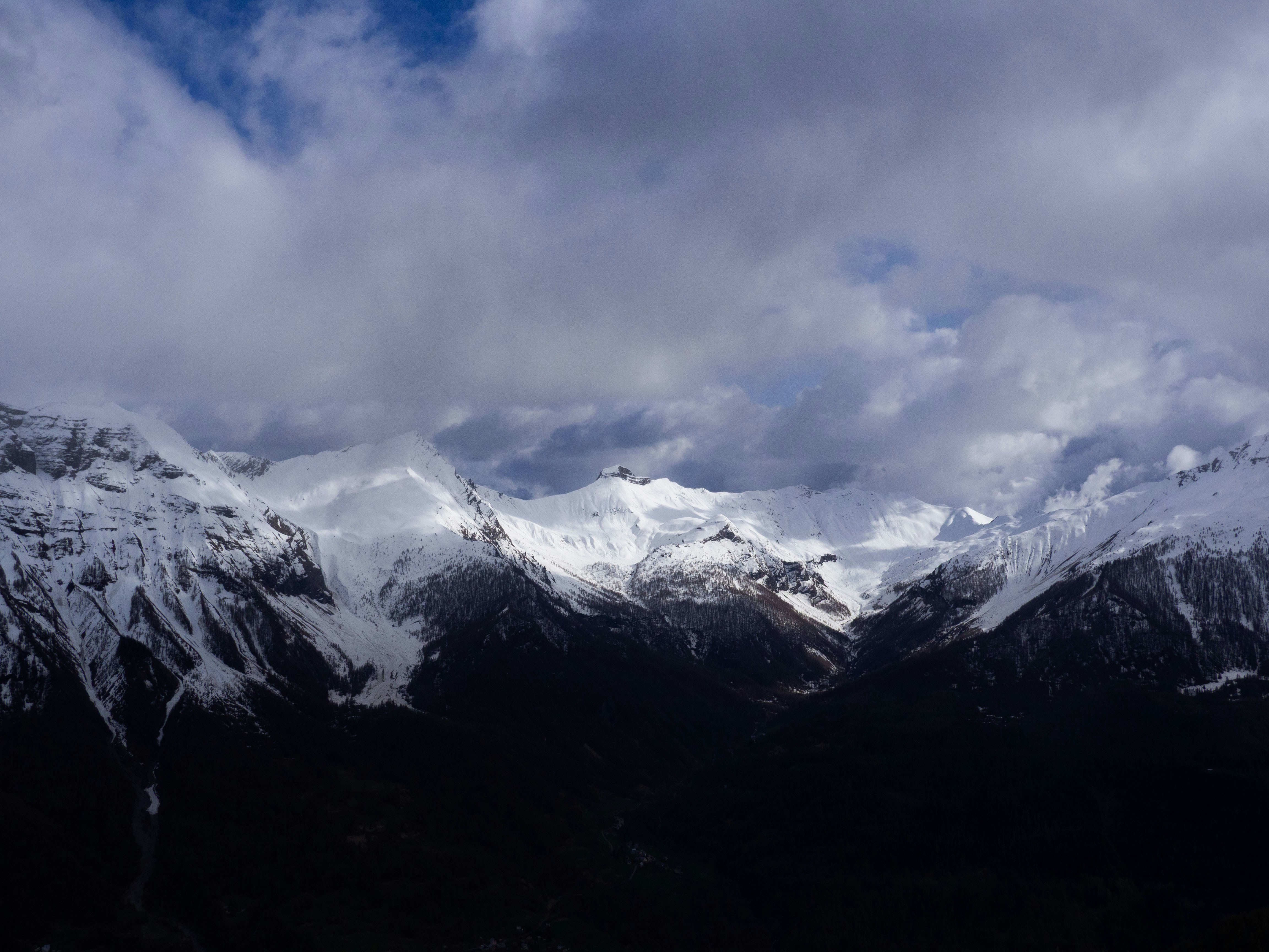 Snowbound Summit Veil Over Dark Valleys