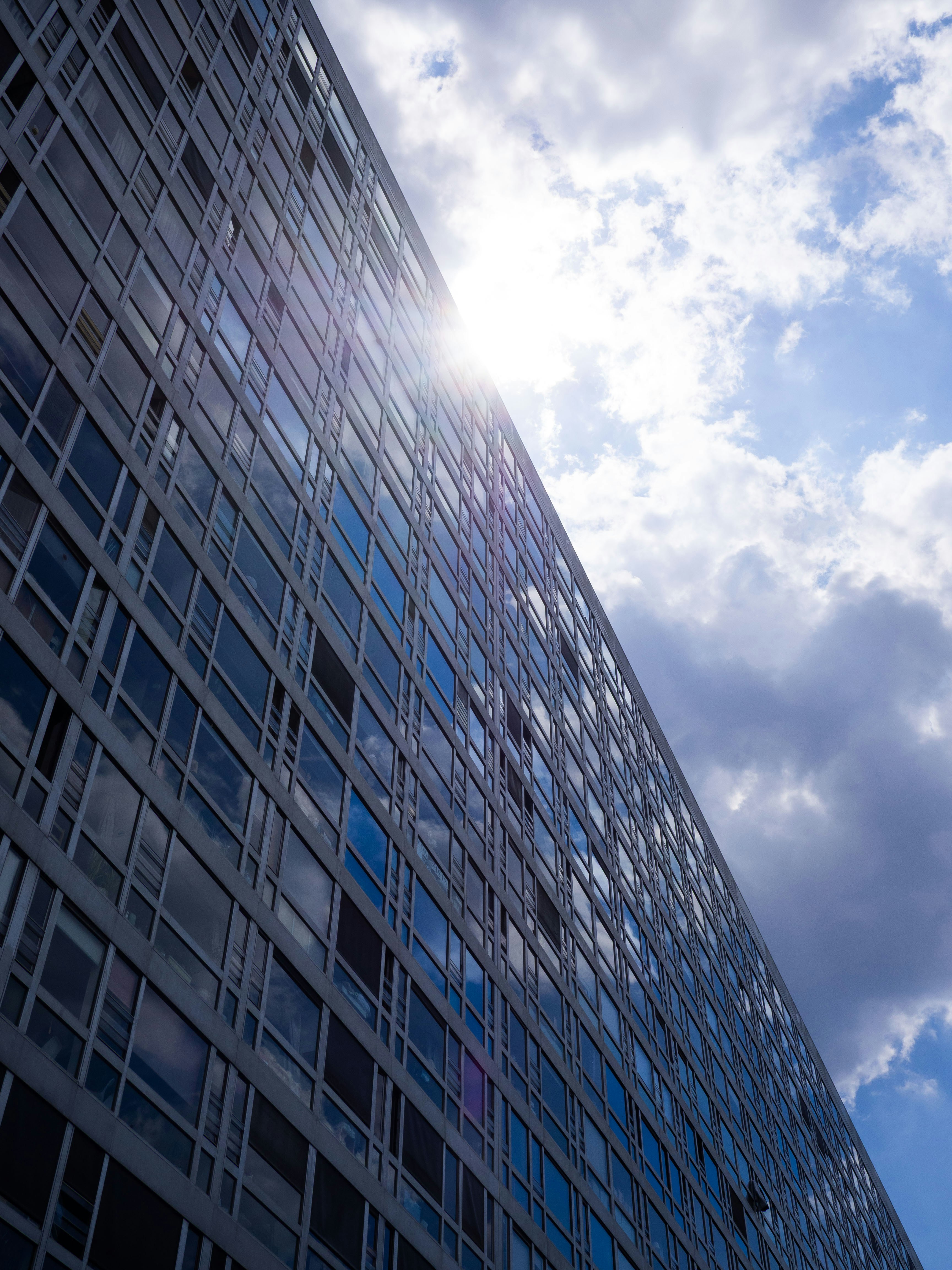 Sunlit Glass Facade Piercing the Sky
