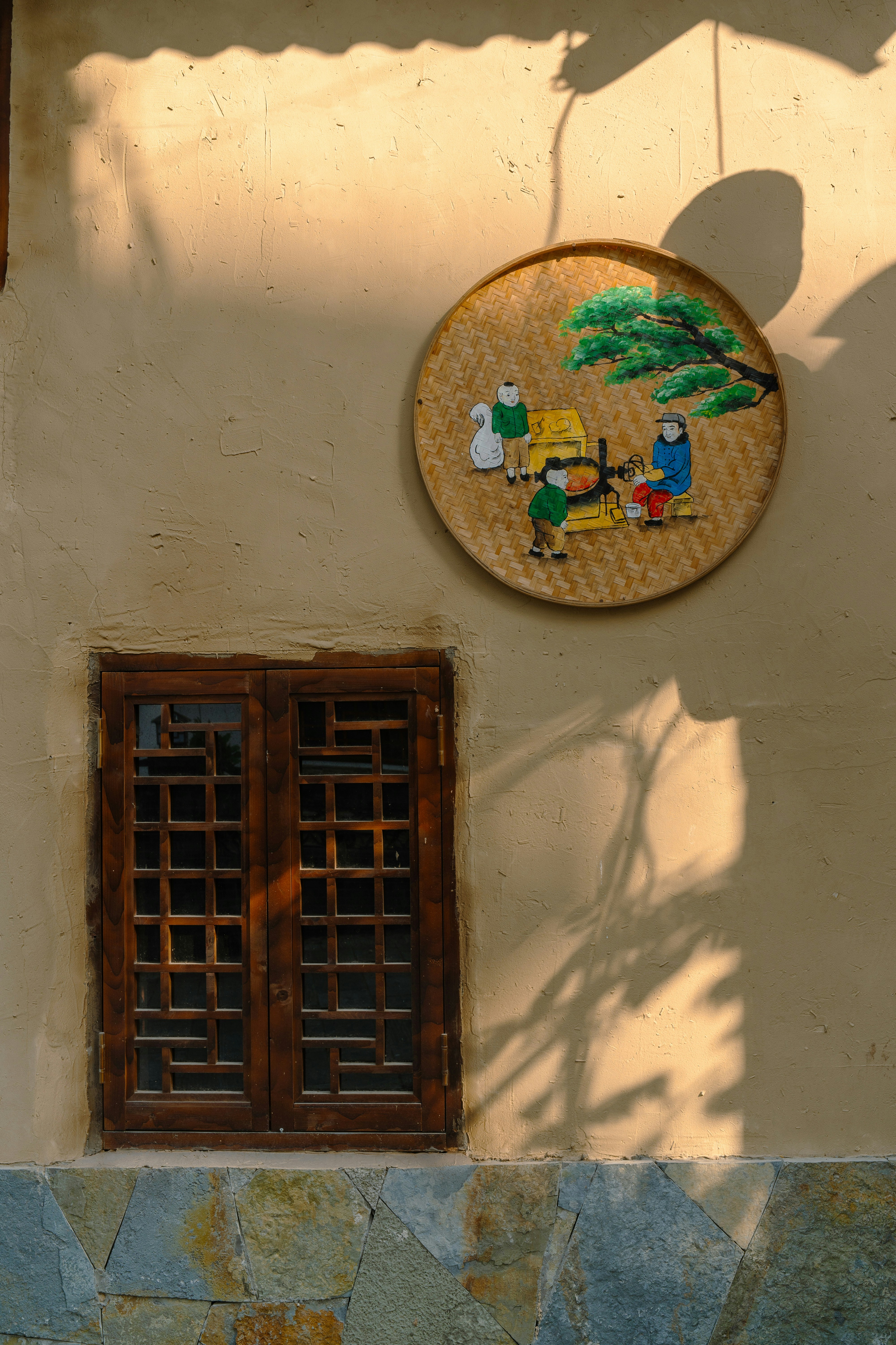 Shaded Courtyard Silhouette and a Circular Artwork
