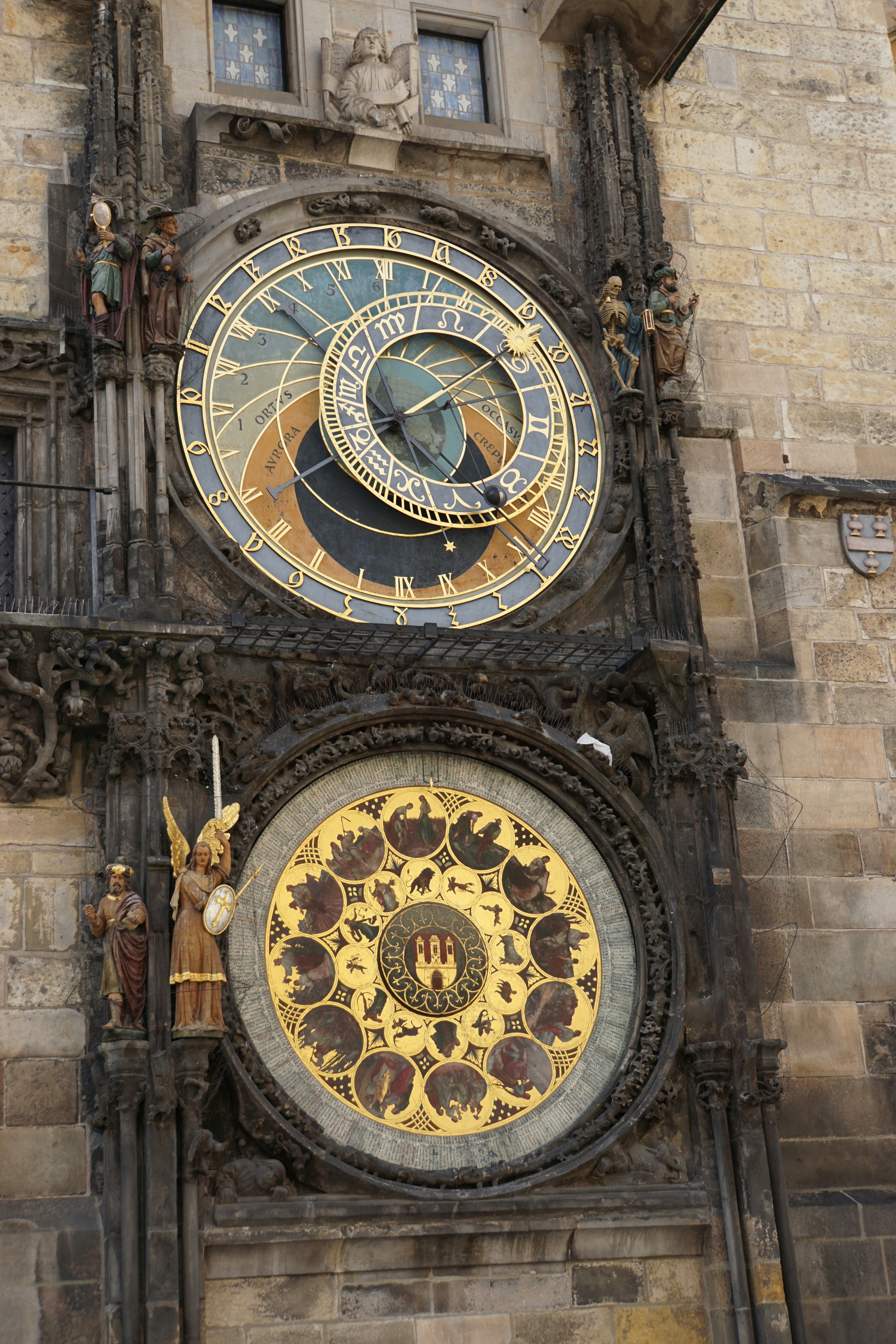 The Astronomical Clock’s Gilded Orbits: Faces of Time in Stone