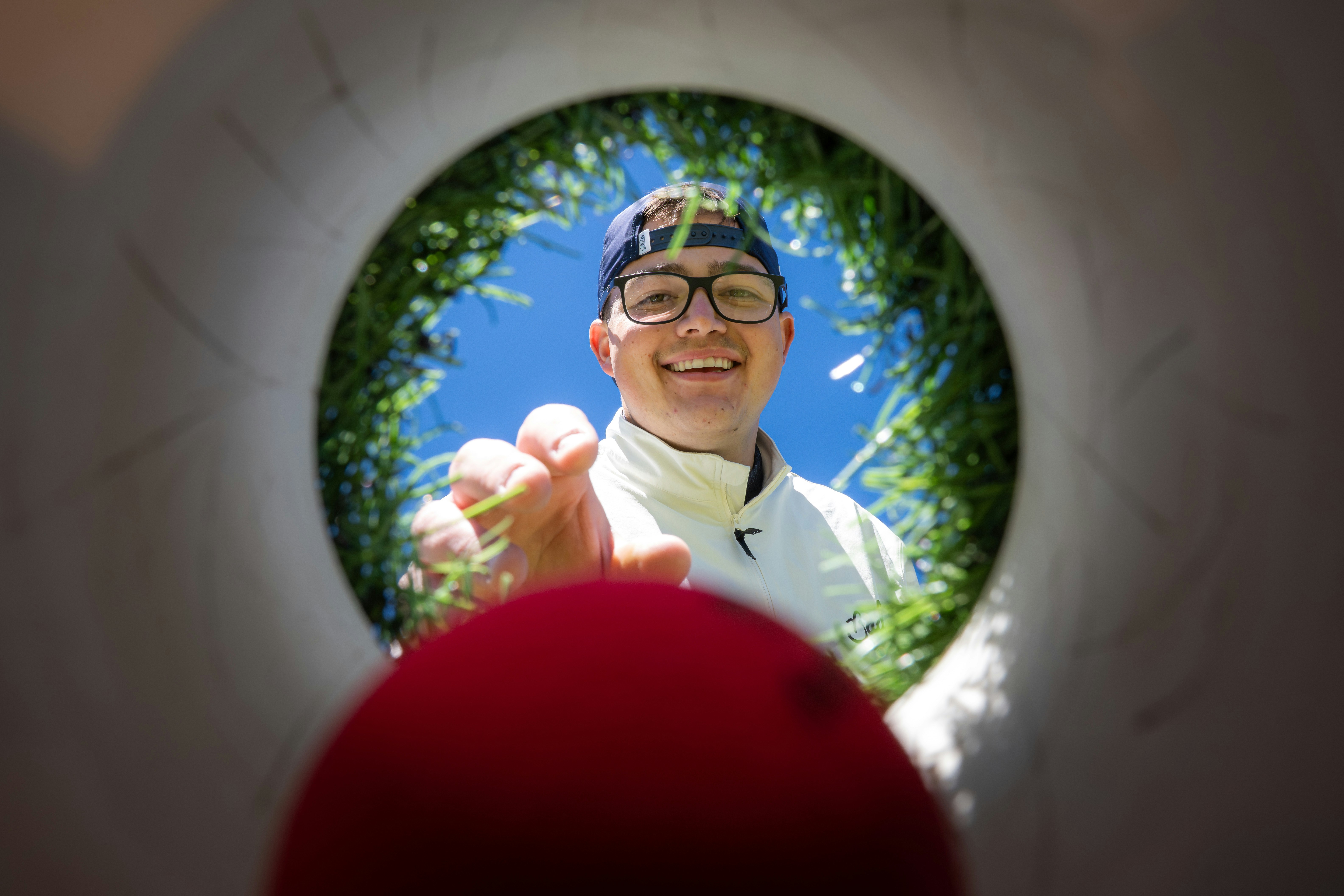 Peering up the Pipe: A Cheerful Lens Captures a Builder’s Grin