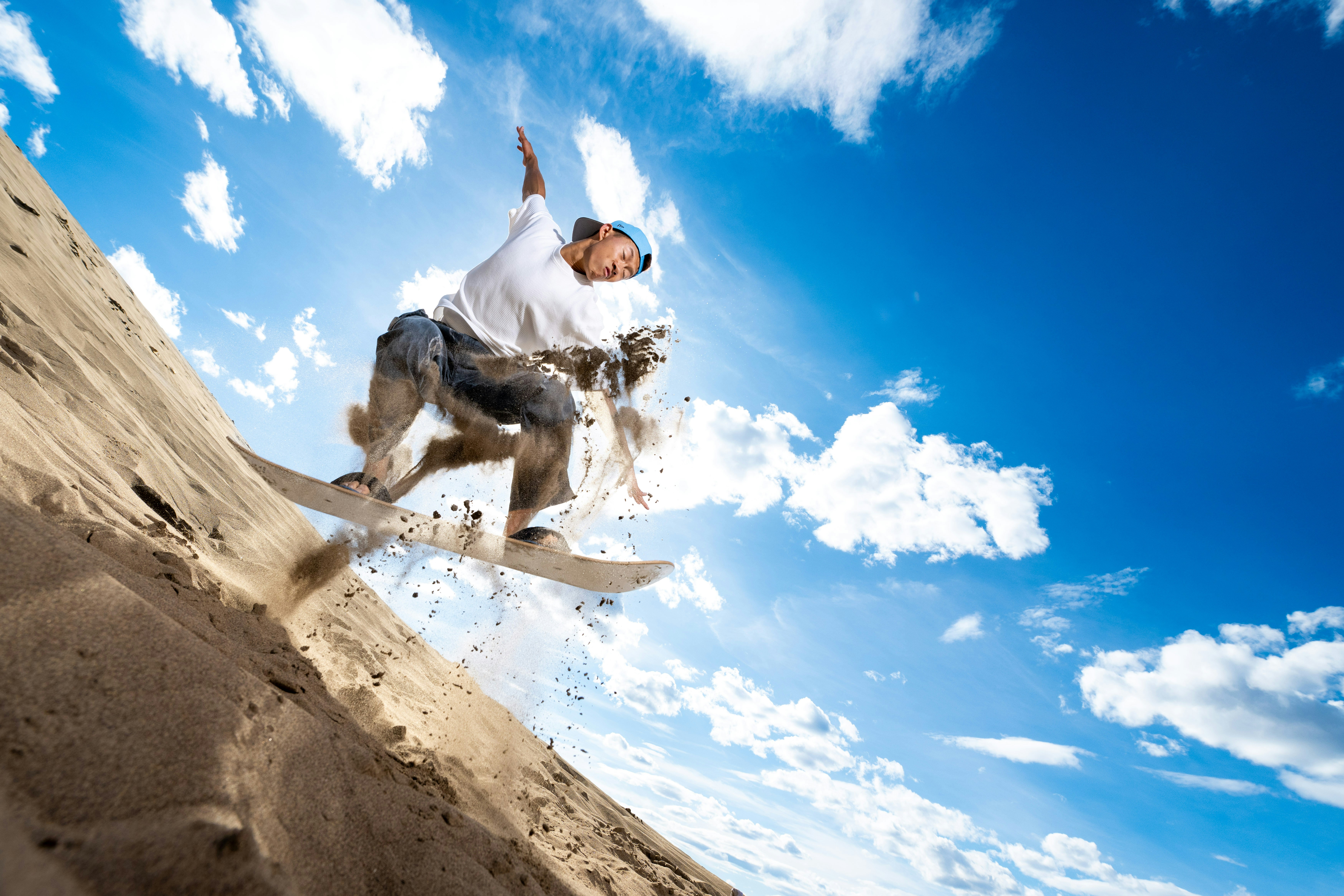 Snowboarder Carving a Sand-Sky Leap
