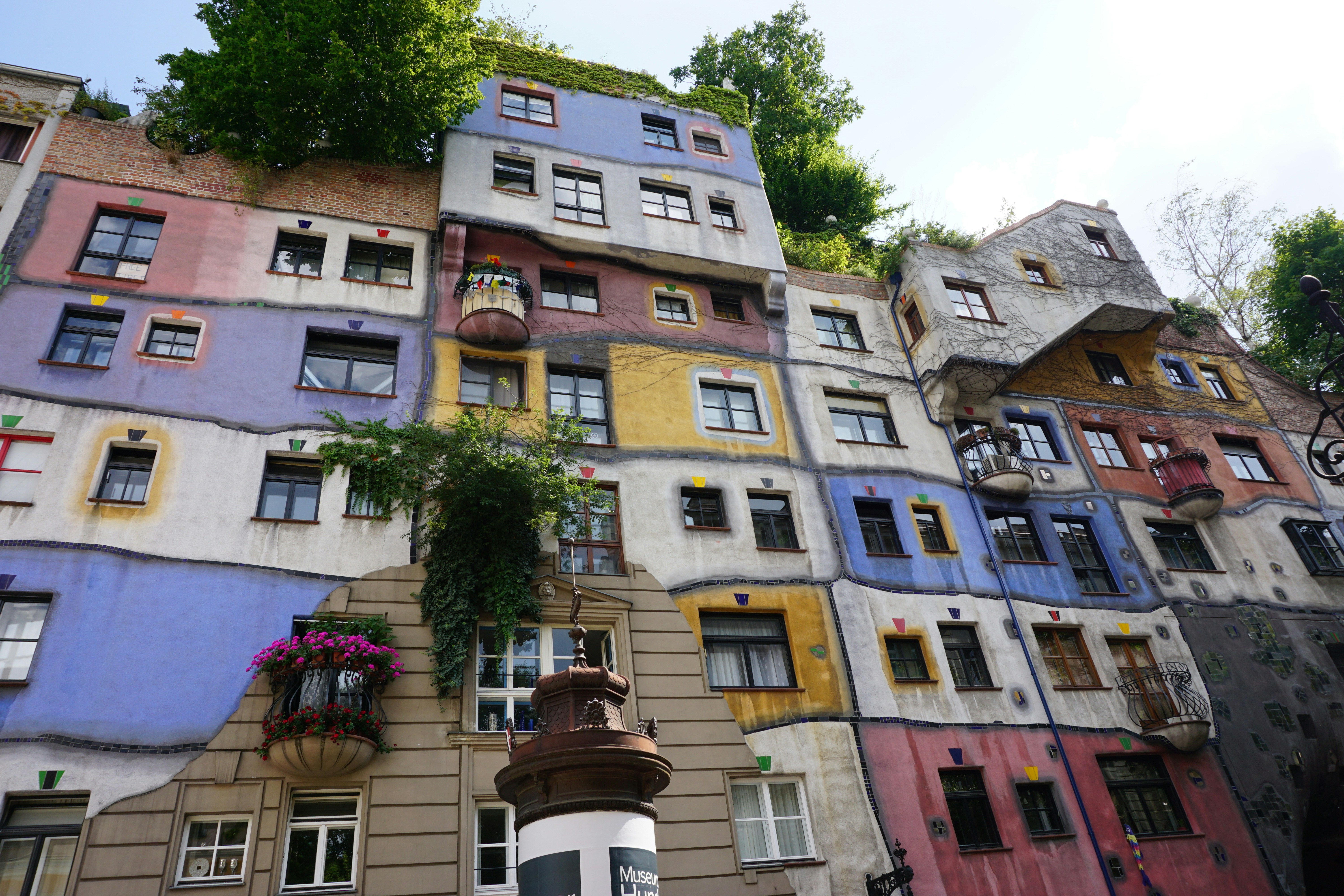 A Living Rainbow: Facades with Hidden Greenery on a Multicolored Building Row
