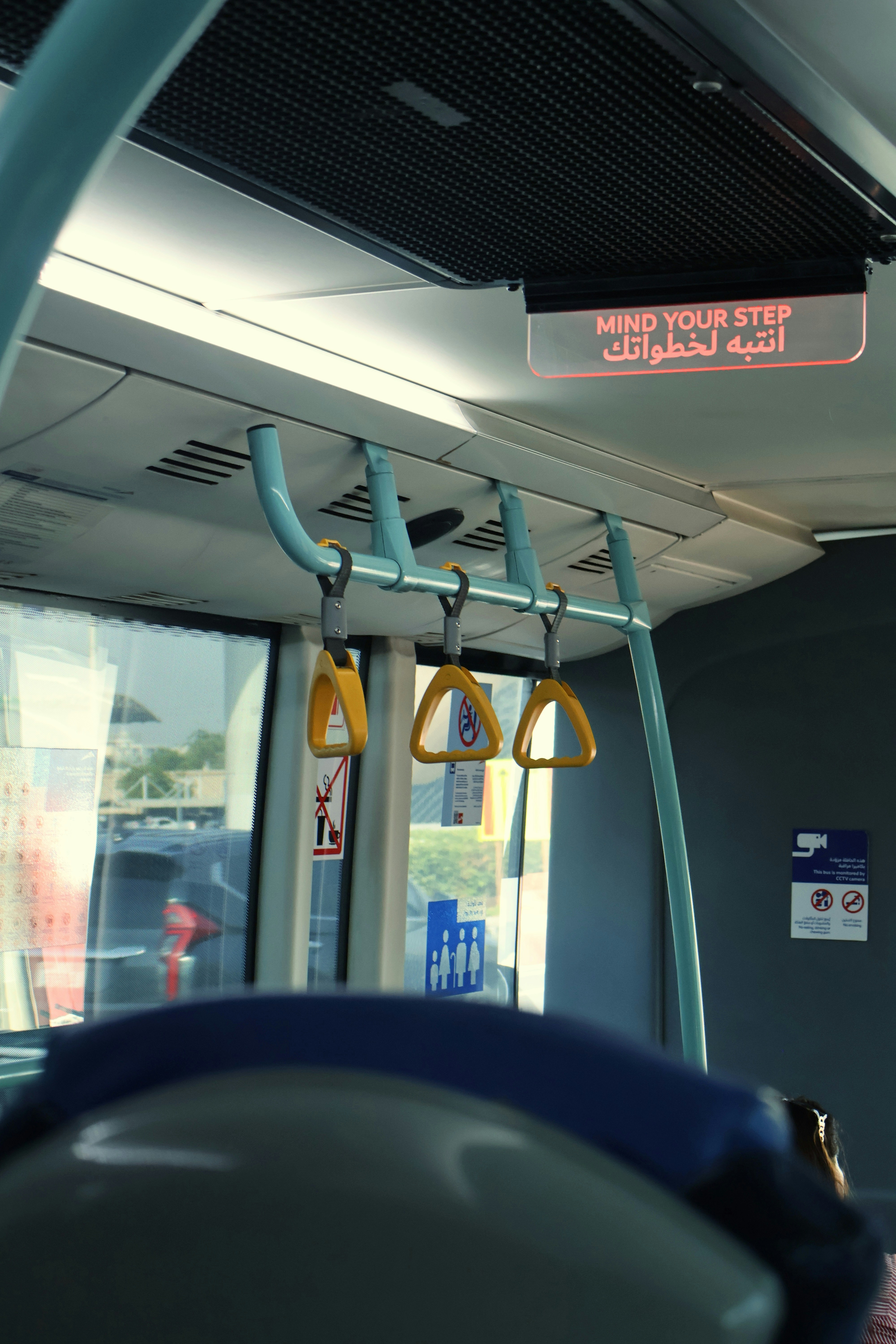 Overhead Handrails and Signage on a Bus Interior