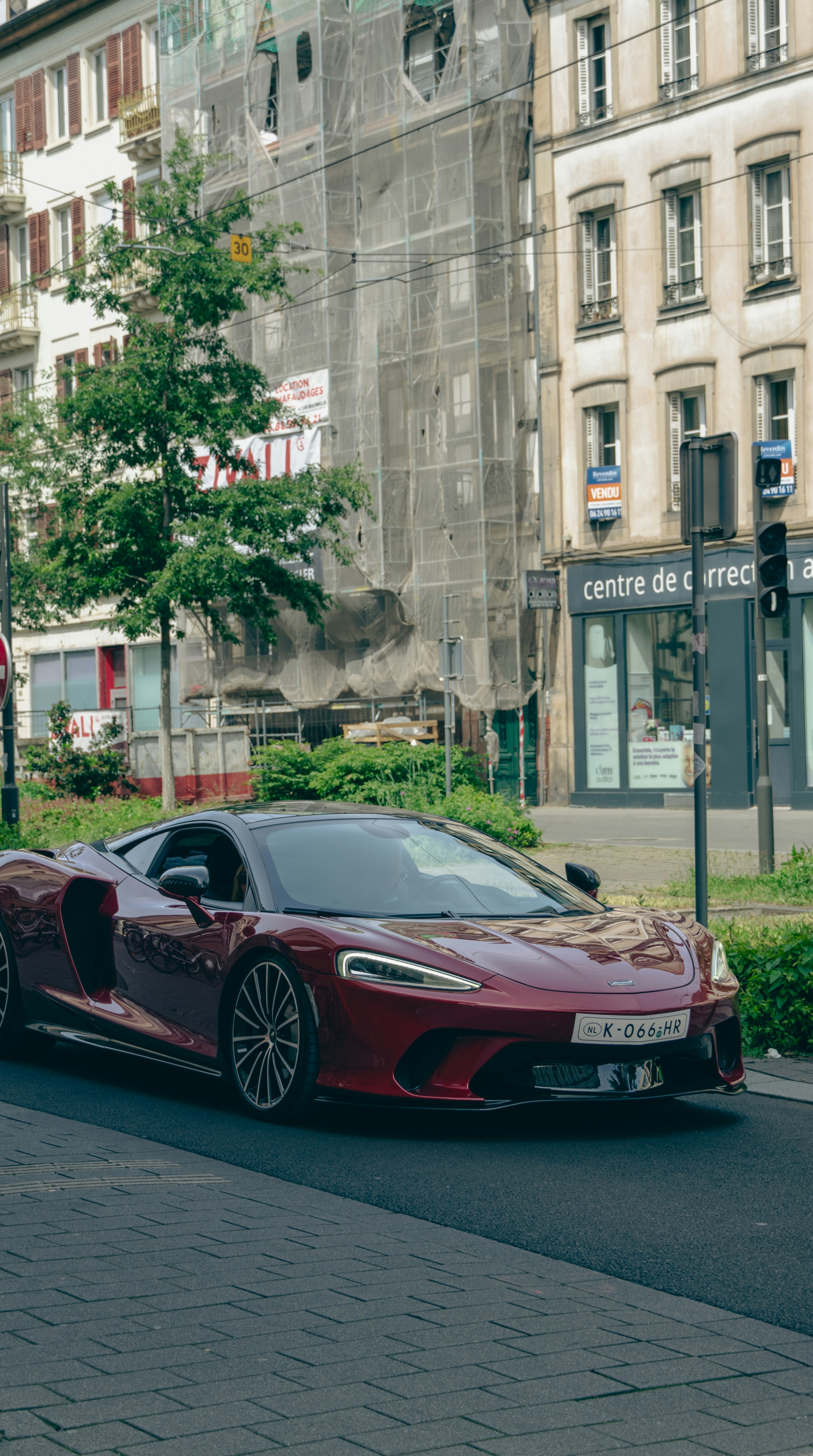 Maroon Avant-Garde: A Hypercar Meets Urban Facades