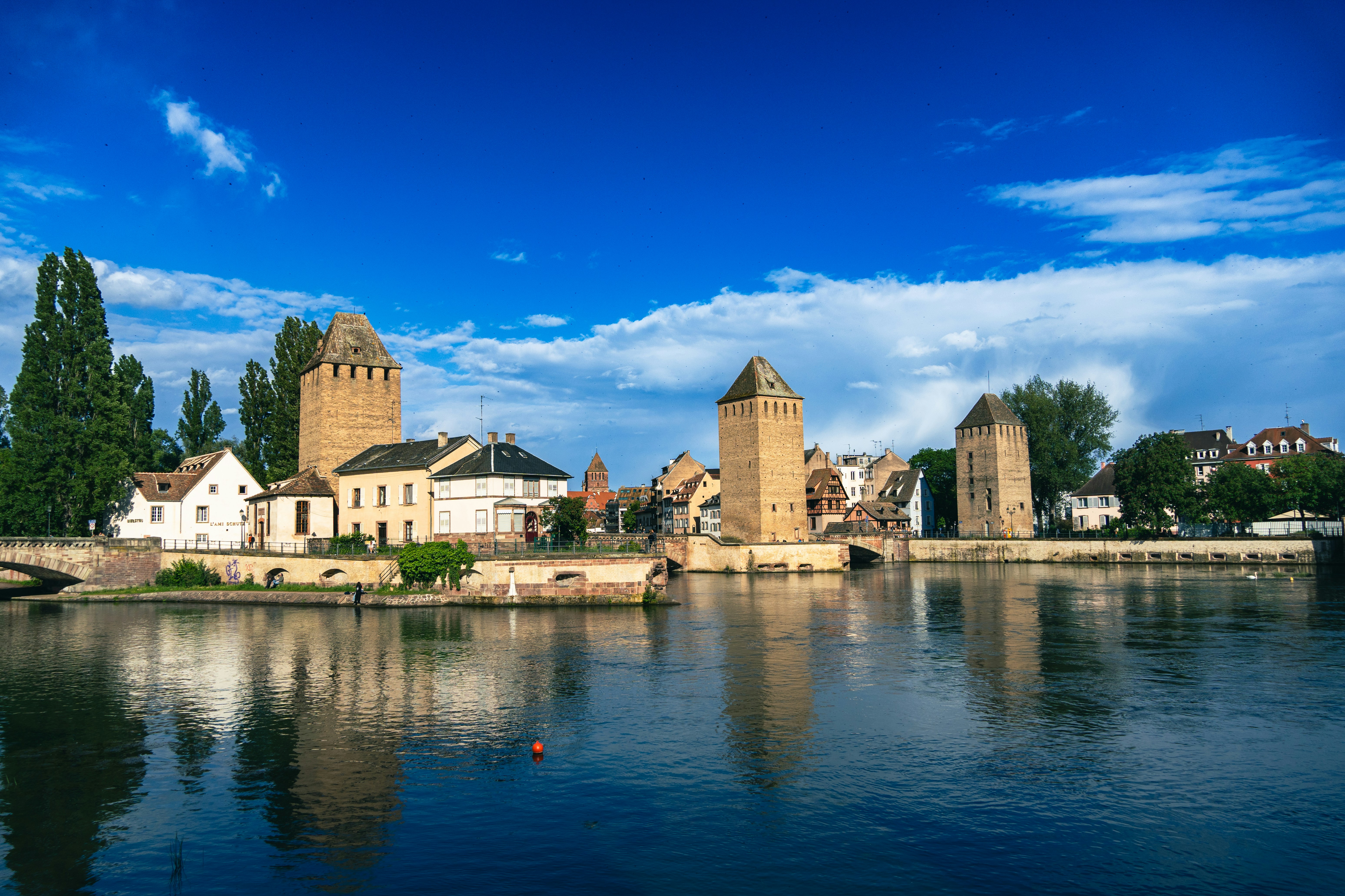 Riverside Citadel: Towers and Bridge Framing a Historic Town