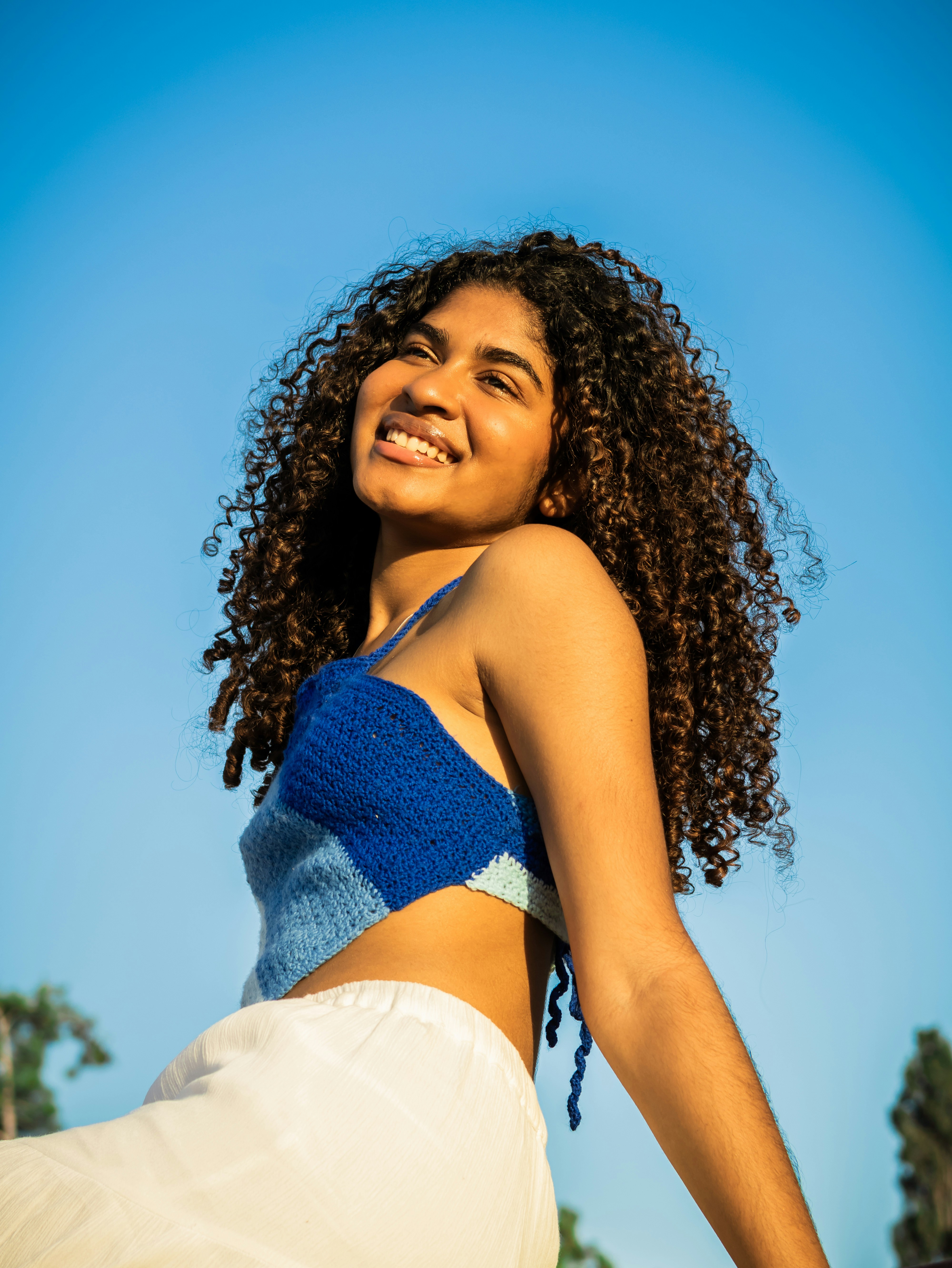Sun-Kissed Confidence: A Leaning Portrait in Blue