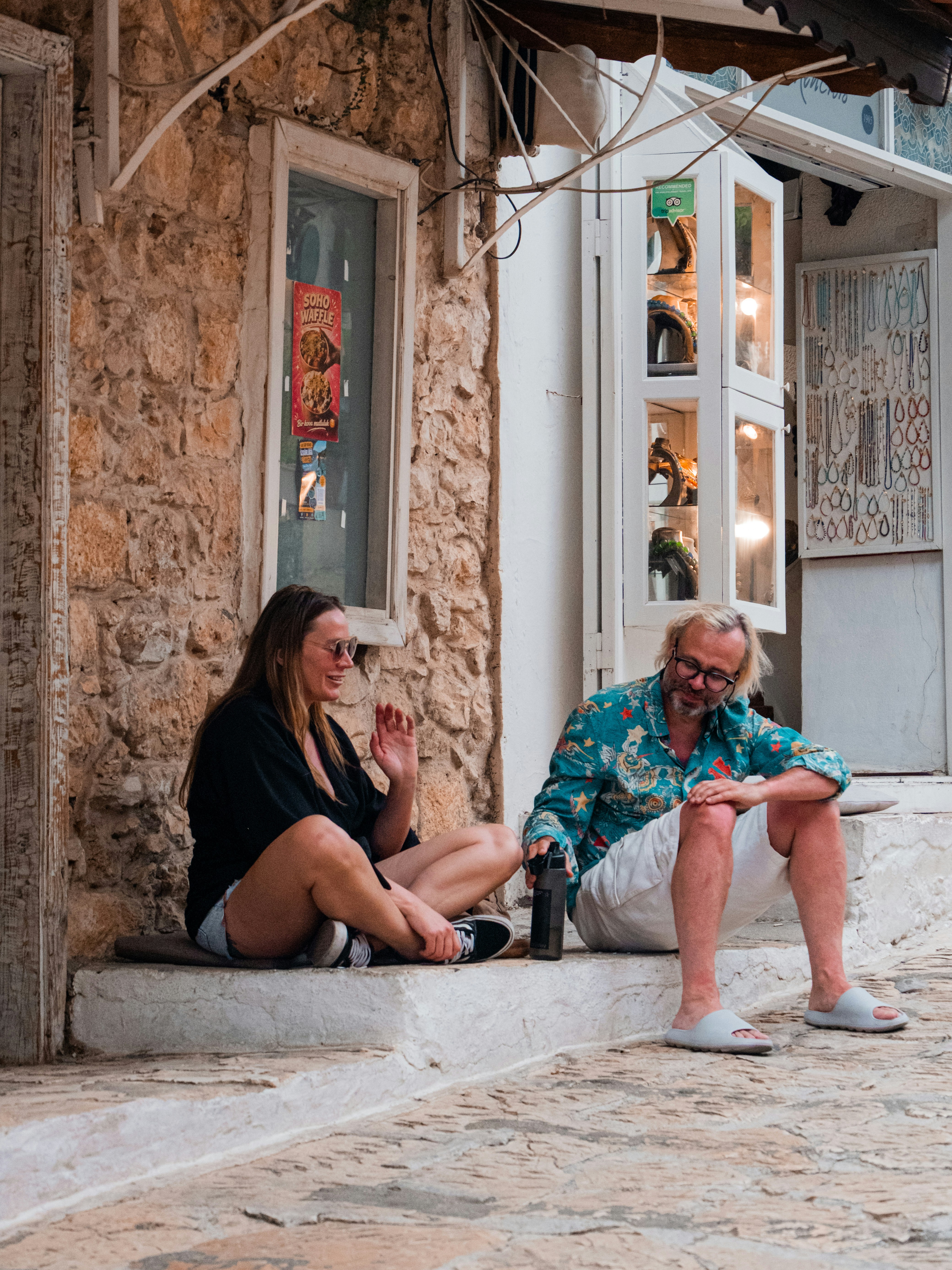 Friends on a Stone Terrace: Conversation Under a Worn Veranda
