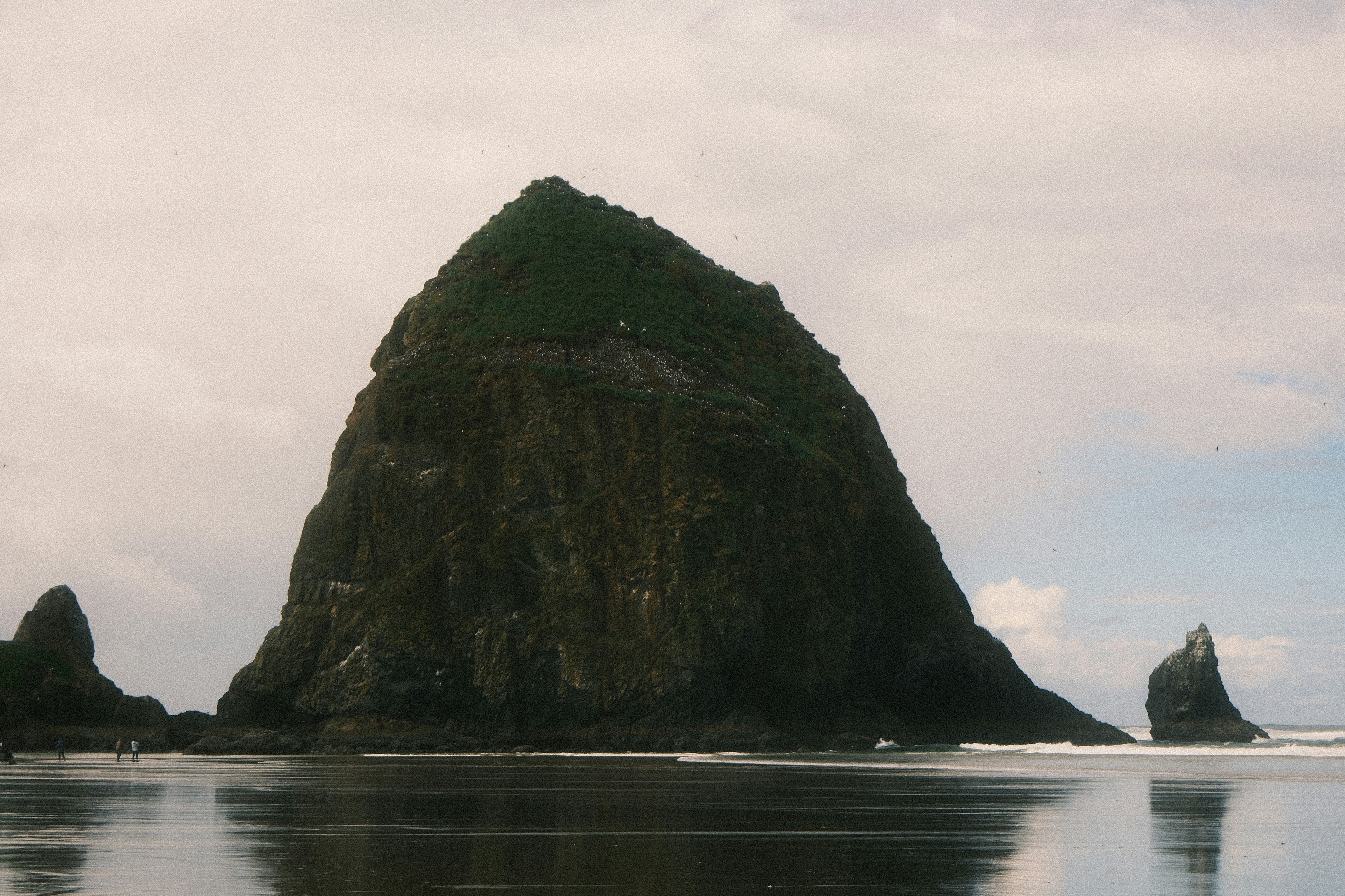 Sea Monolith: A Lone Coastal Sentinel Rises From Tidal Slabs