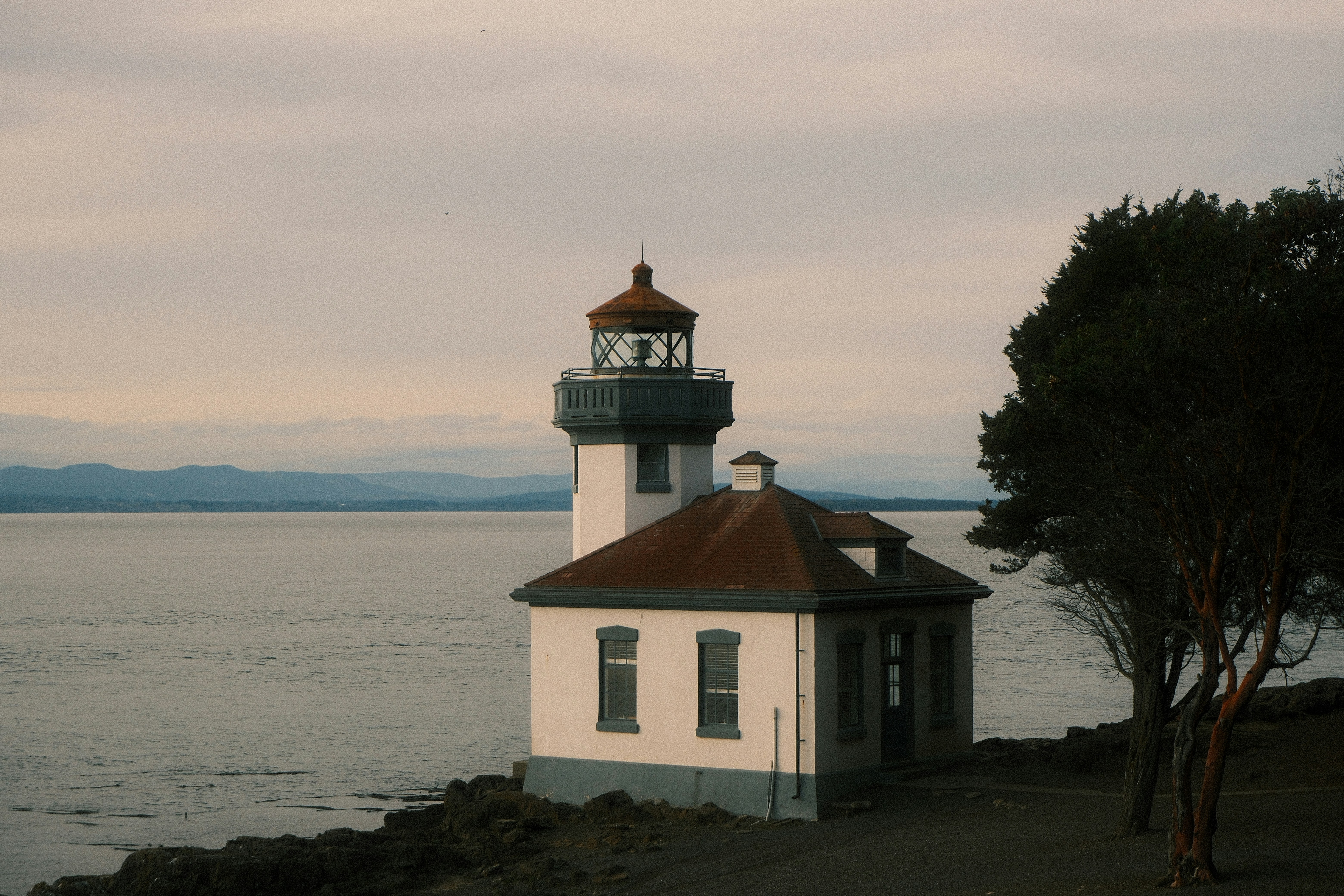 Lighthouse at the Edge: A Quiet Harbor Portrait