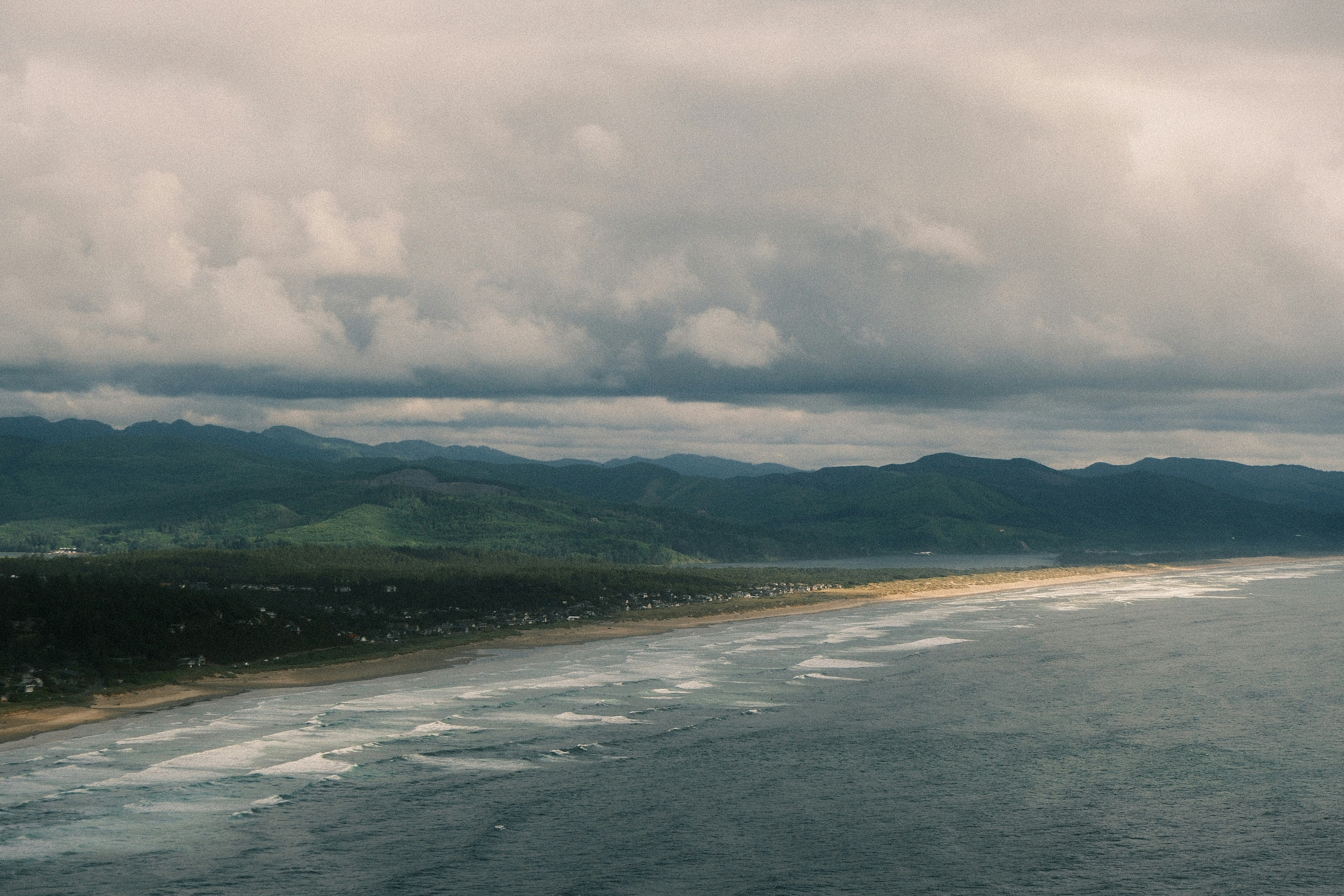 Coastal Ridge Under Brooding Clouds
