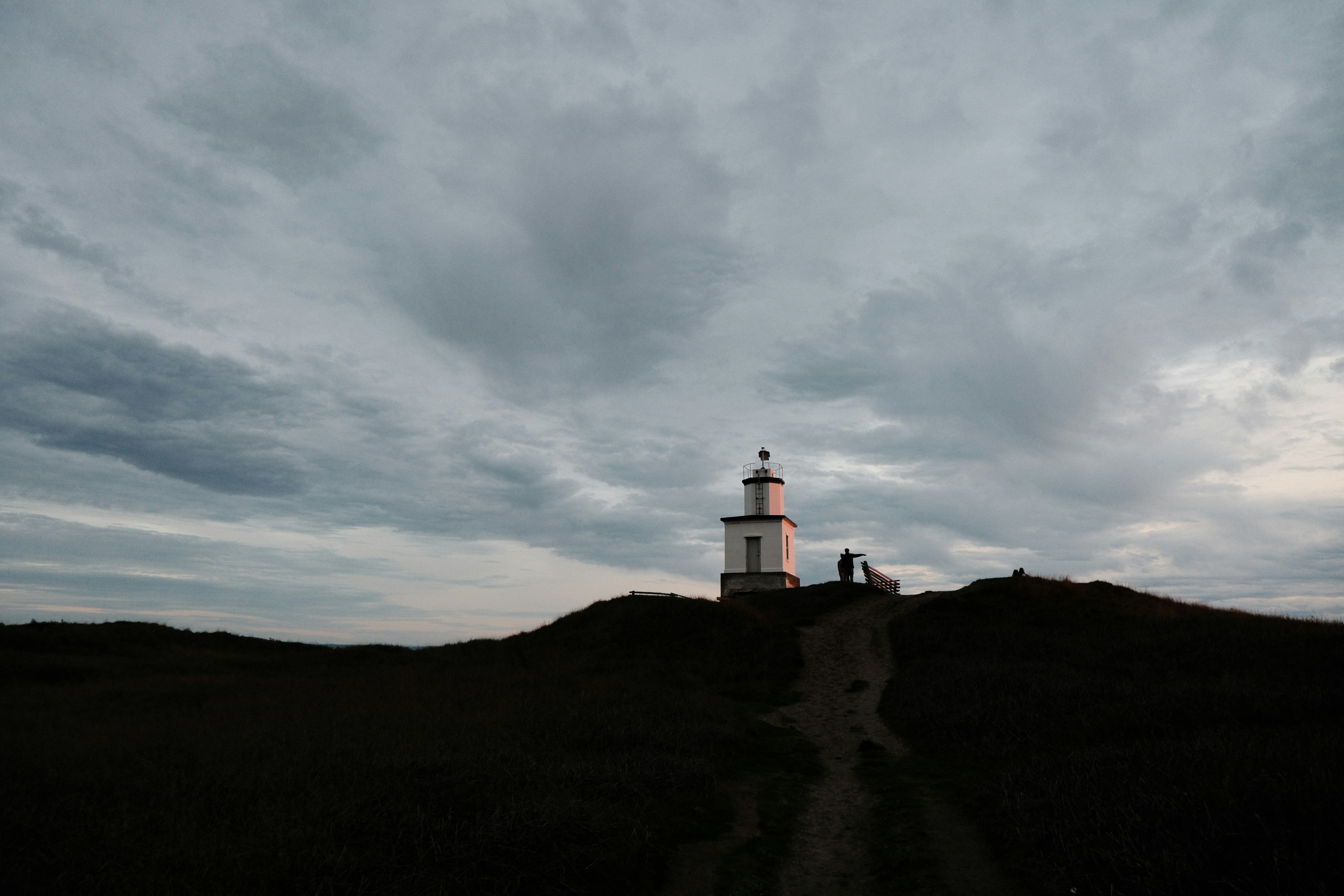 Lighthouse Sentinel at Dusk: A Quiet Path to the Coast