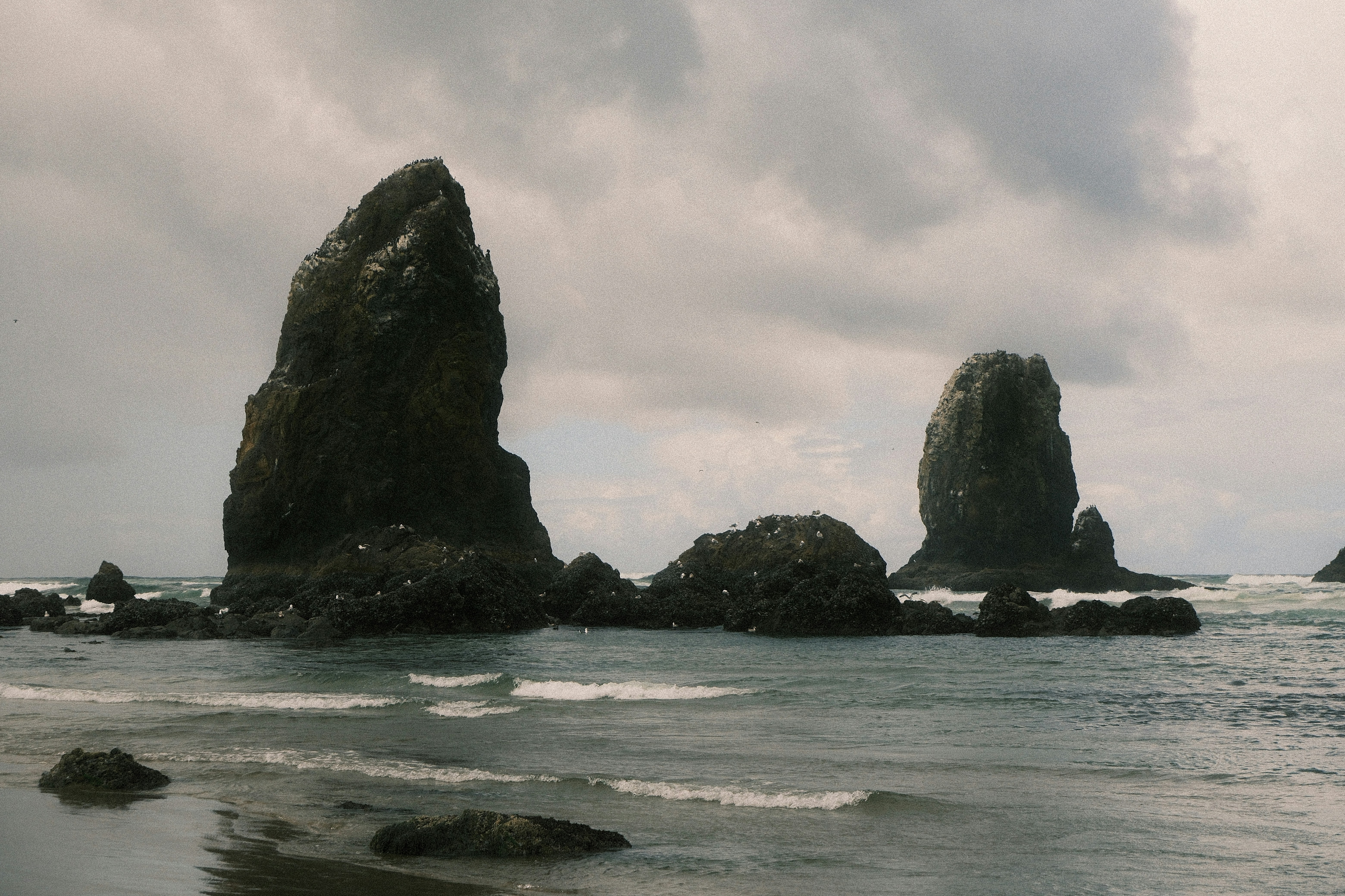 Sea Giants: Two Offshore Monoliths Standing Against a Grey Sky