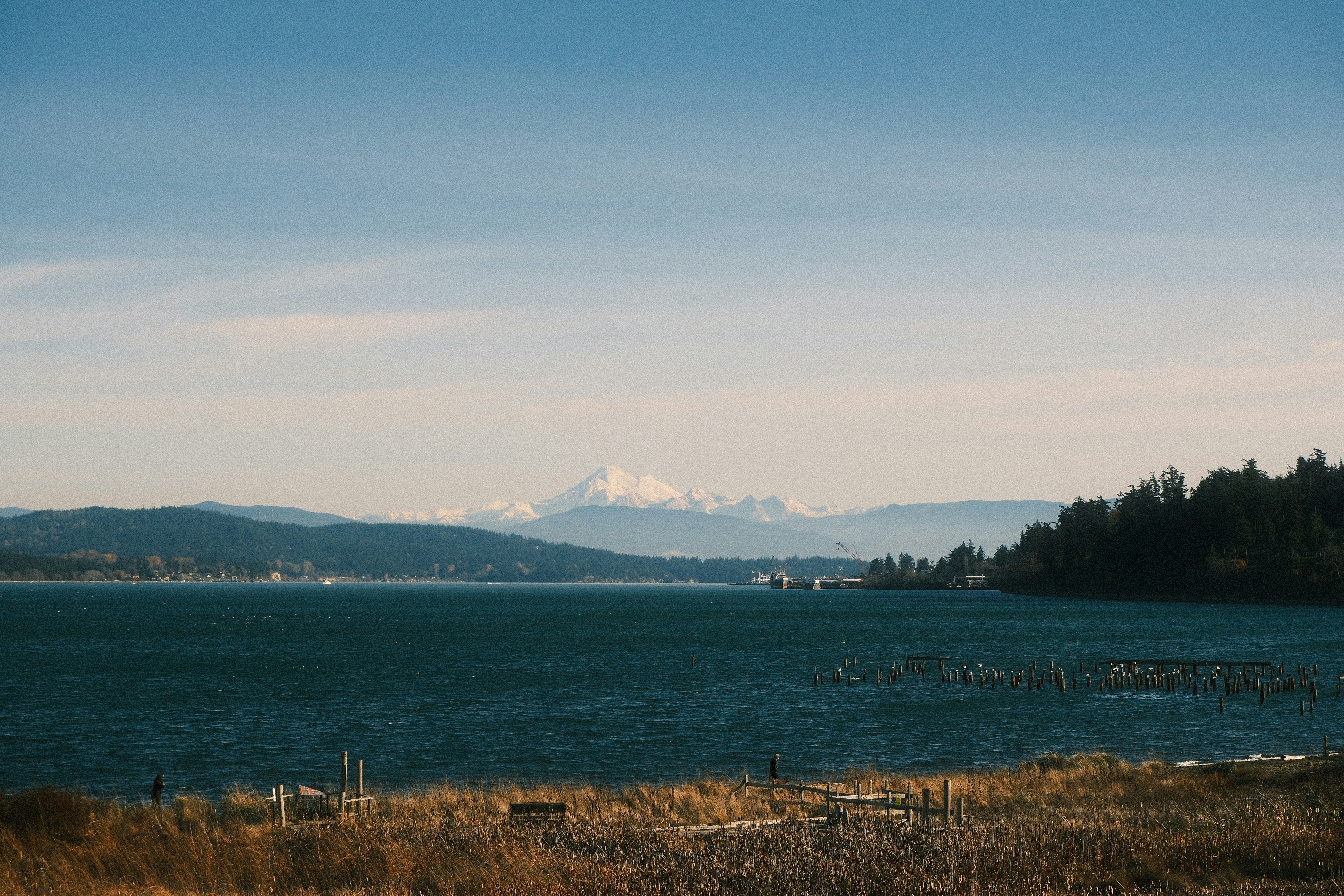 Snow-capped Peak on the Horizon: A Quiet Coastal Panorama