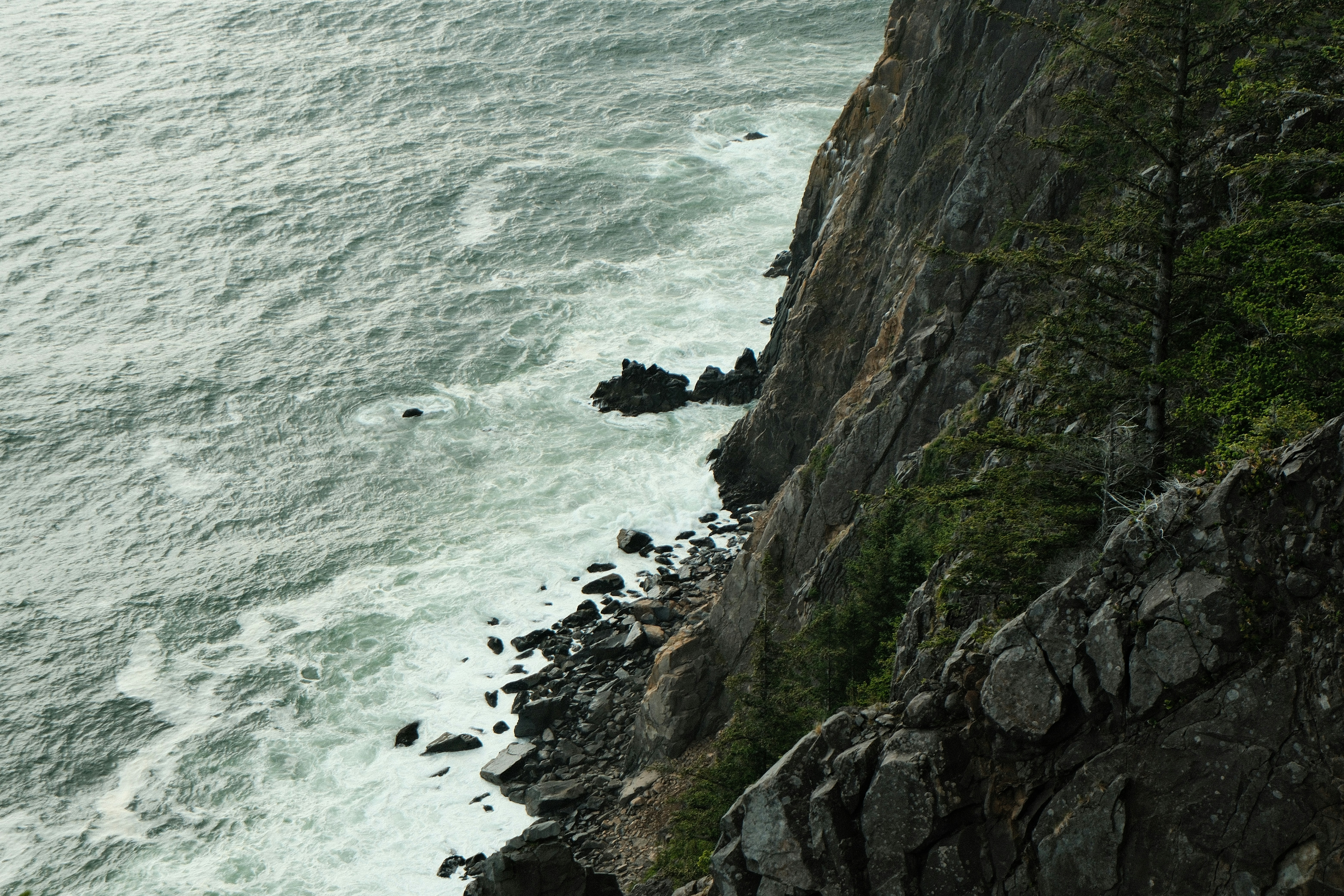 Littoral Edge: Cliffside Coastline Meets Turbulent Sea