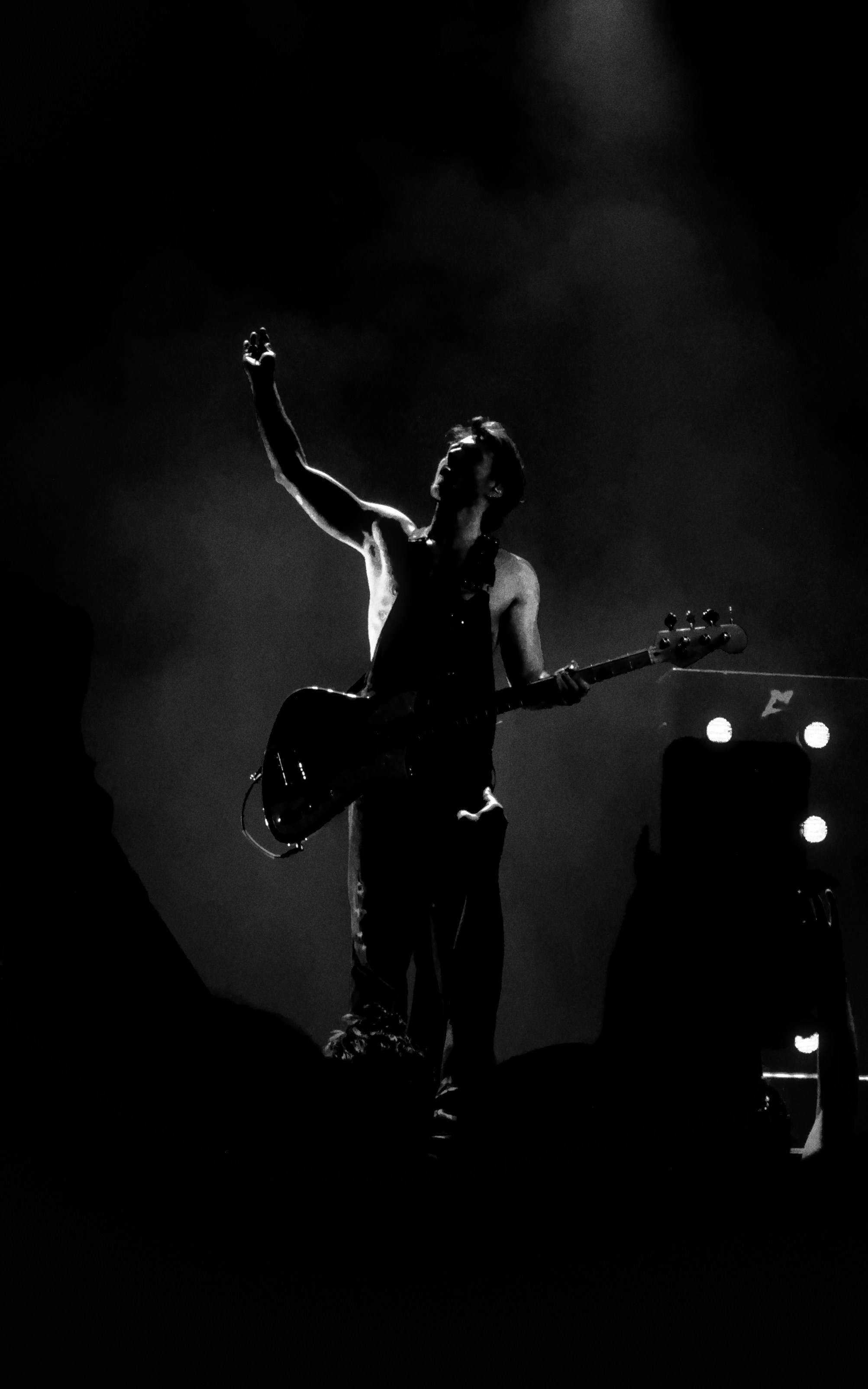 Midnight Strings: Silhouette of a Lead Guitarist under Stage Spotlight