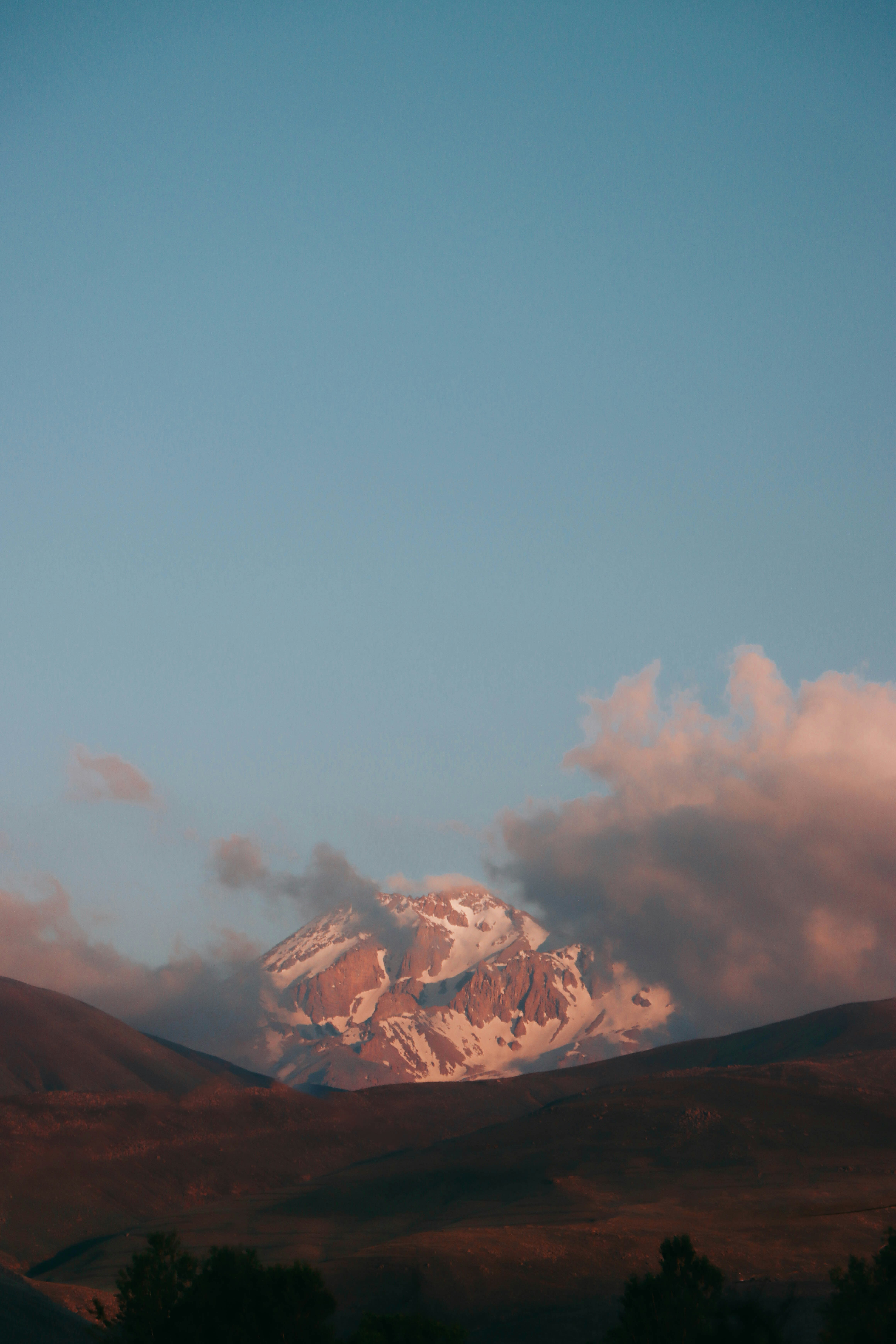 Snow-crowned Peak Graze Under a Peach-tinted Sky
