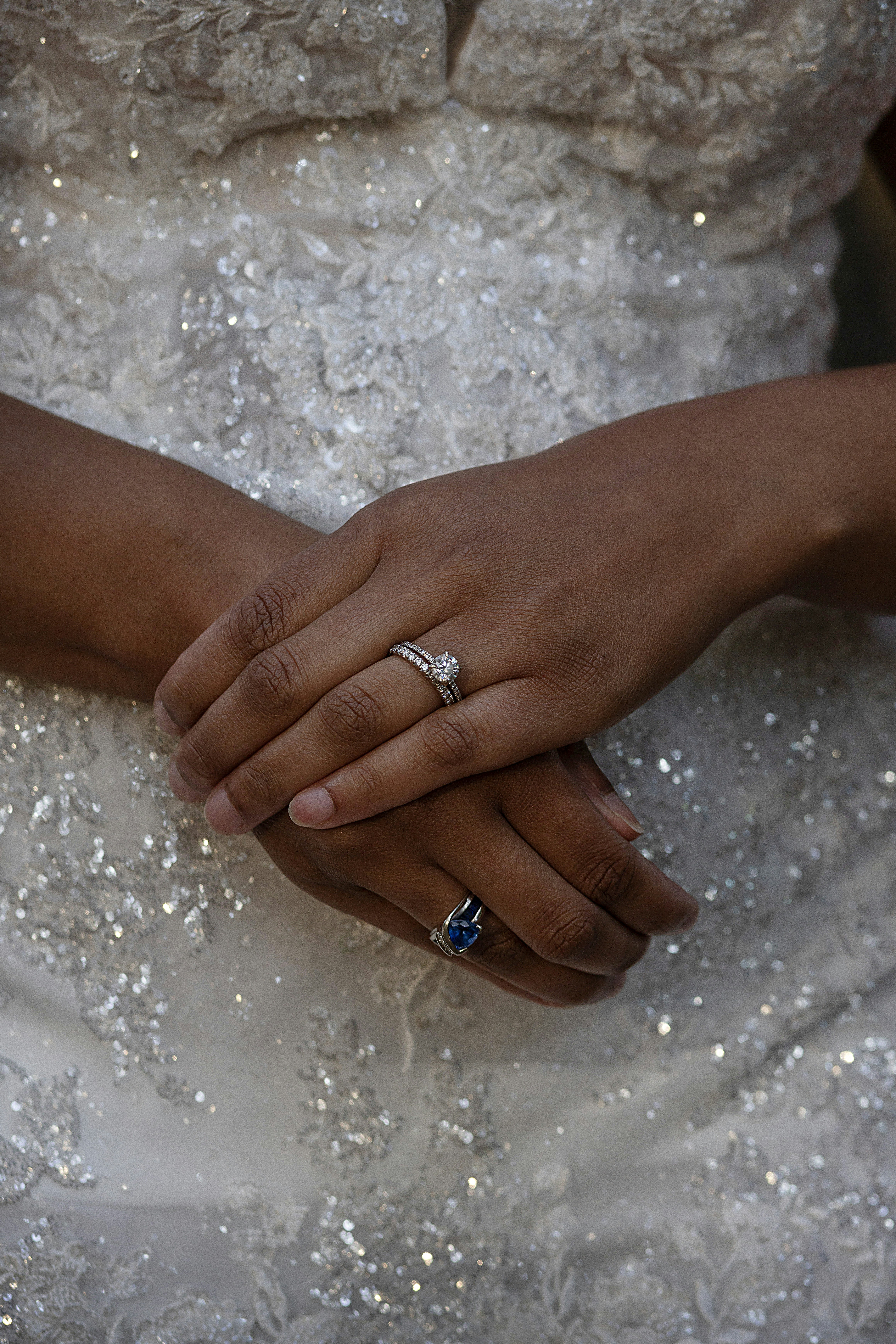 Wedding Rings Rest on a Lace-Sparkled Sleeve