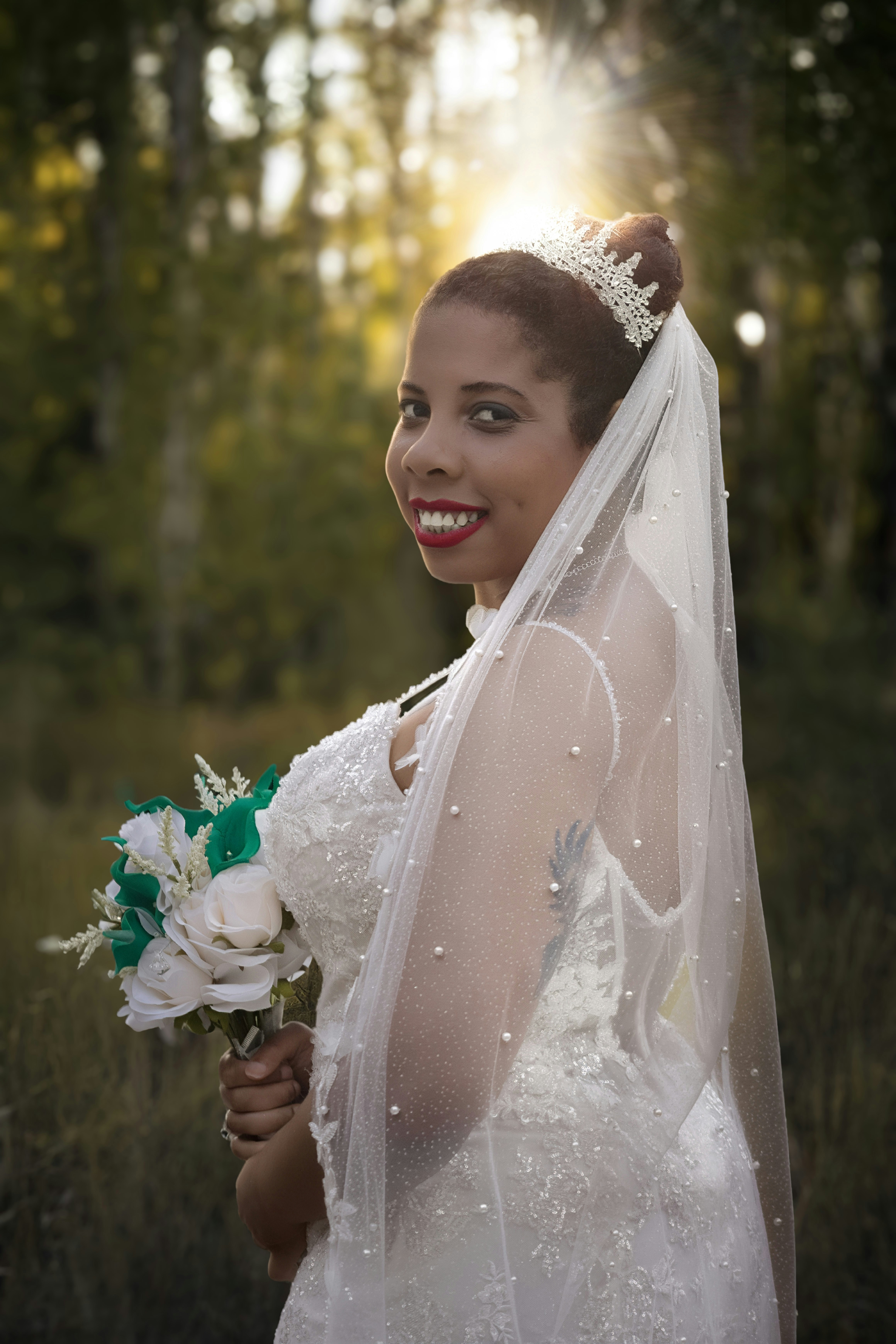 Bride in Backlit Glow: Veil, Pearls, and a Forest Drive