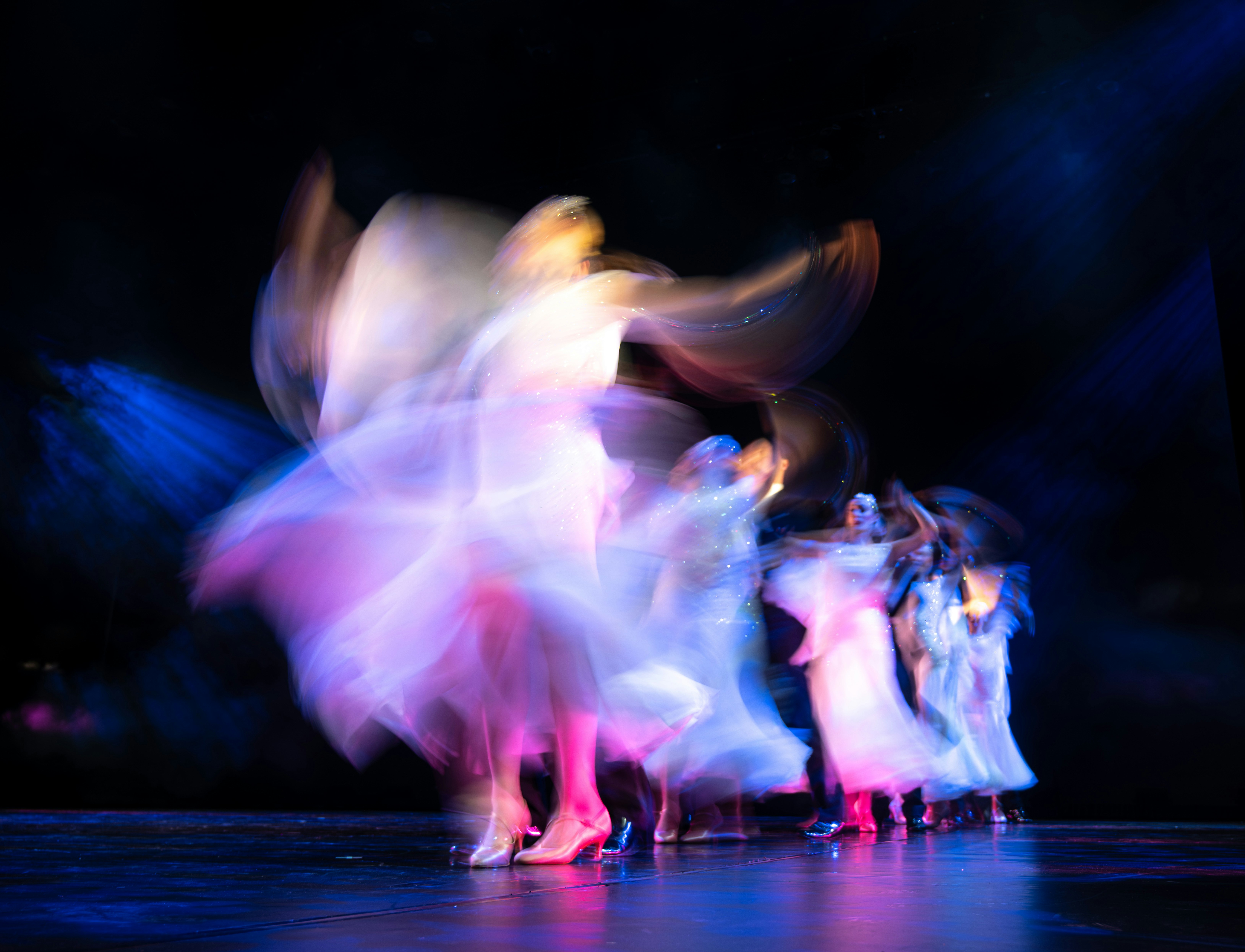 Whirl of Silk: A Blurred Ballet in Deep Stage Light