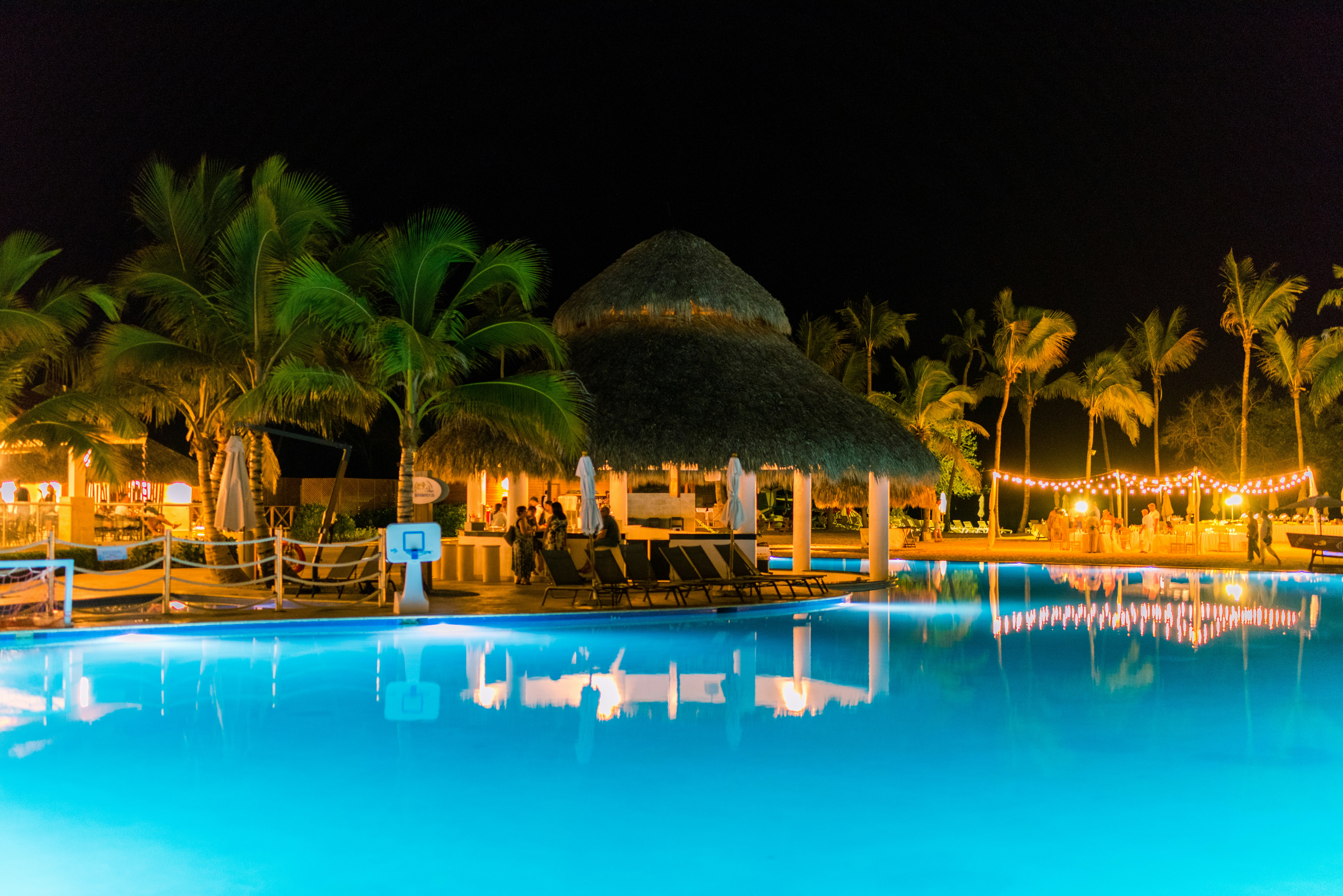 Under a Lagoon Night: Neon Turquoise Reflections by the Pool