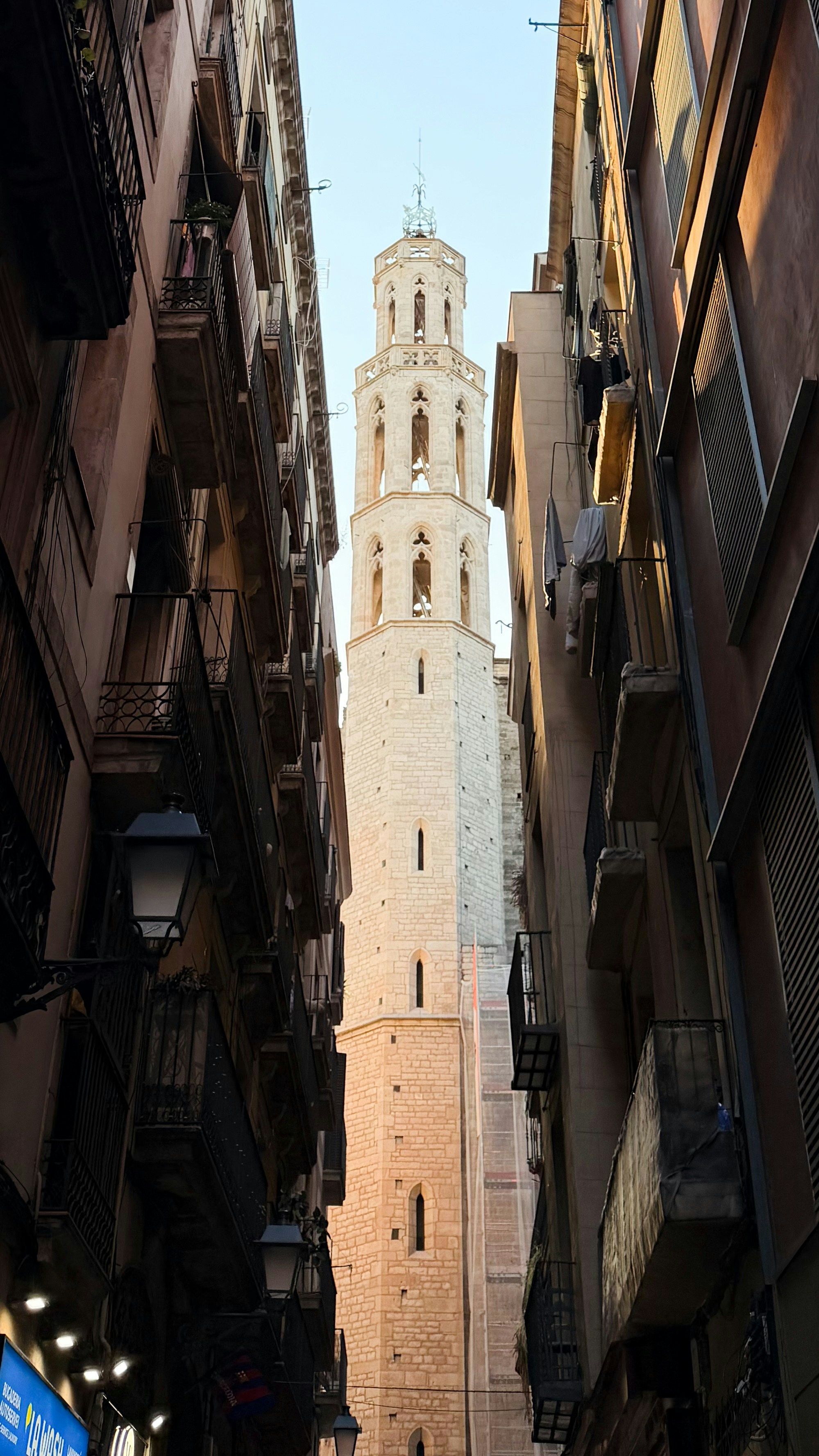 Towering Light: Narrow Street Leads to a Sunlit Bell Tower