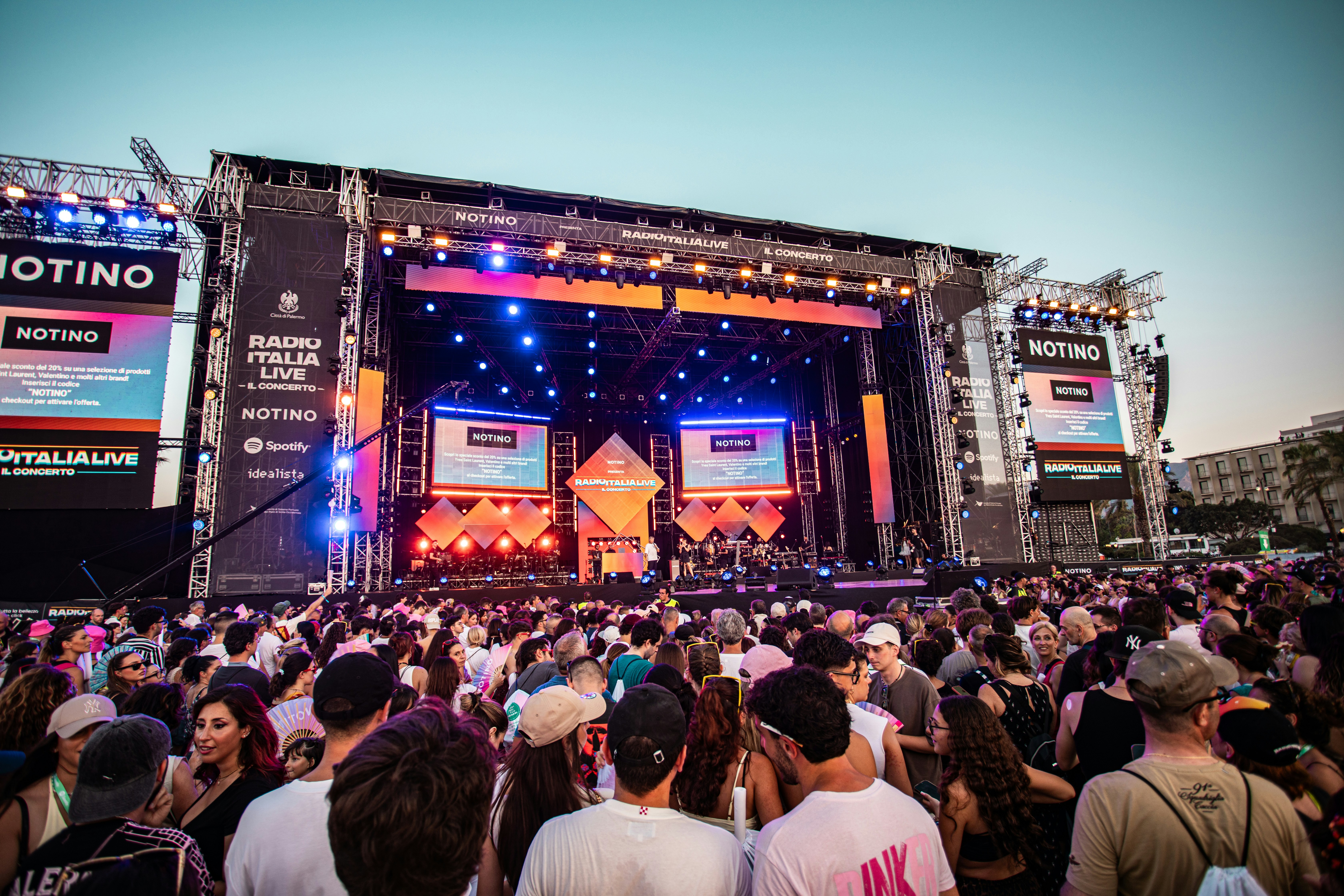 Crowd Surge at a Luminous Outdoor Stage