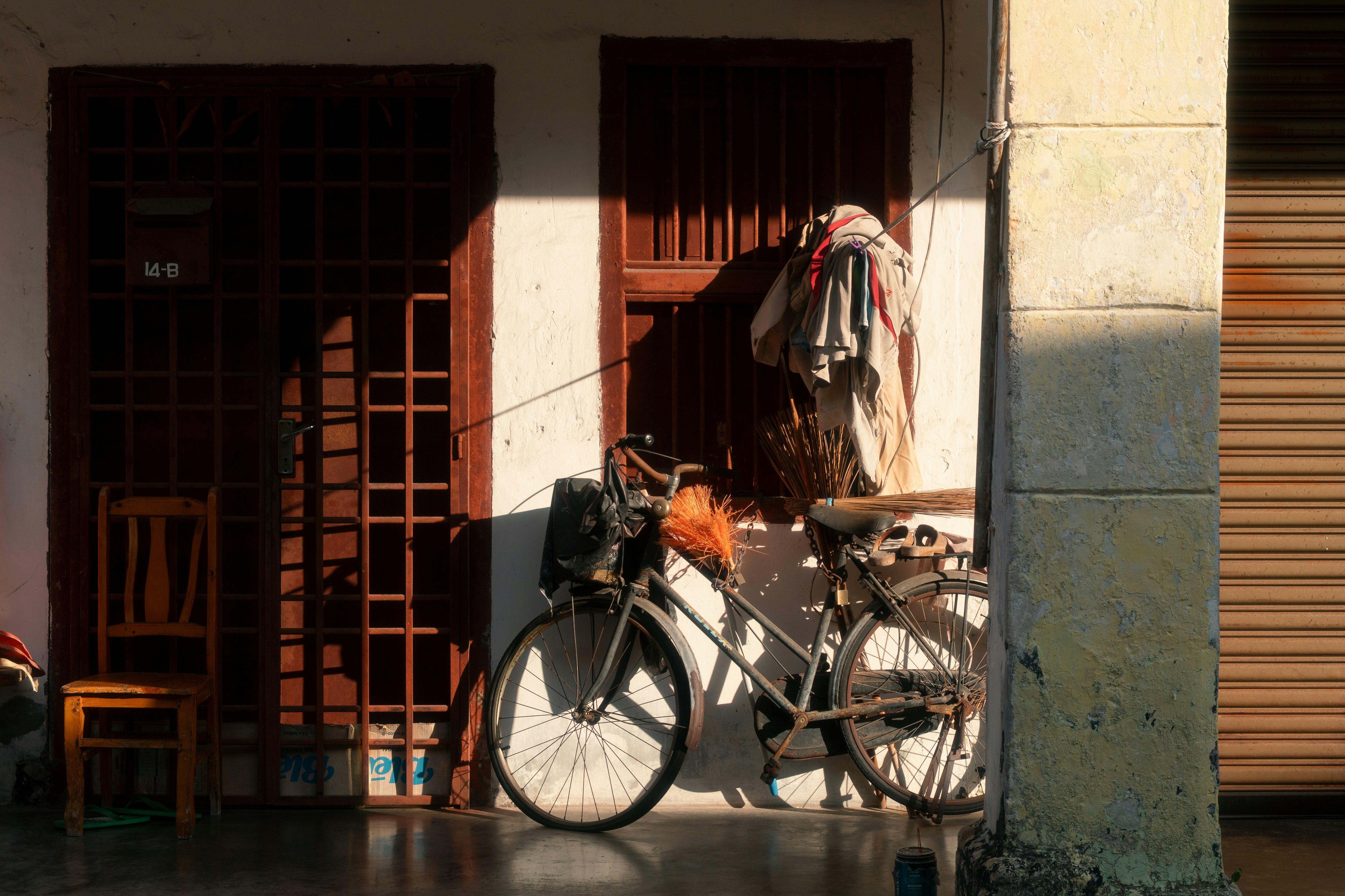 Sunlit Bicycle and Umbrella in a Quiet Alley