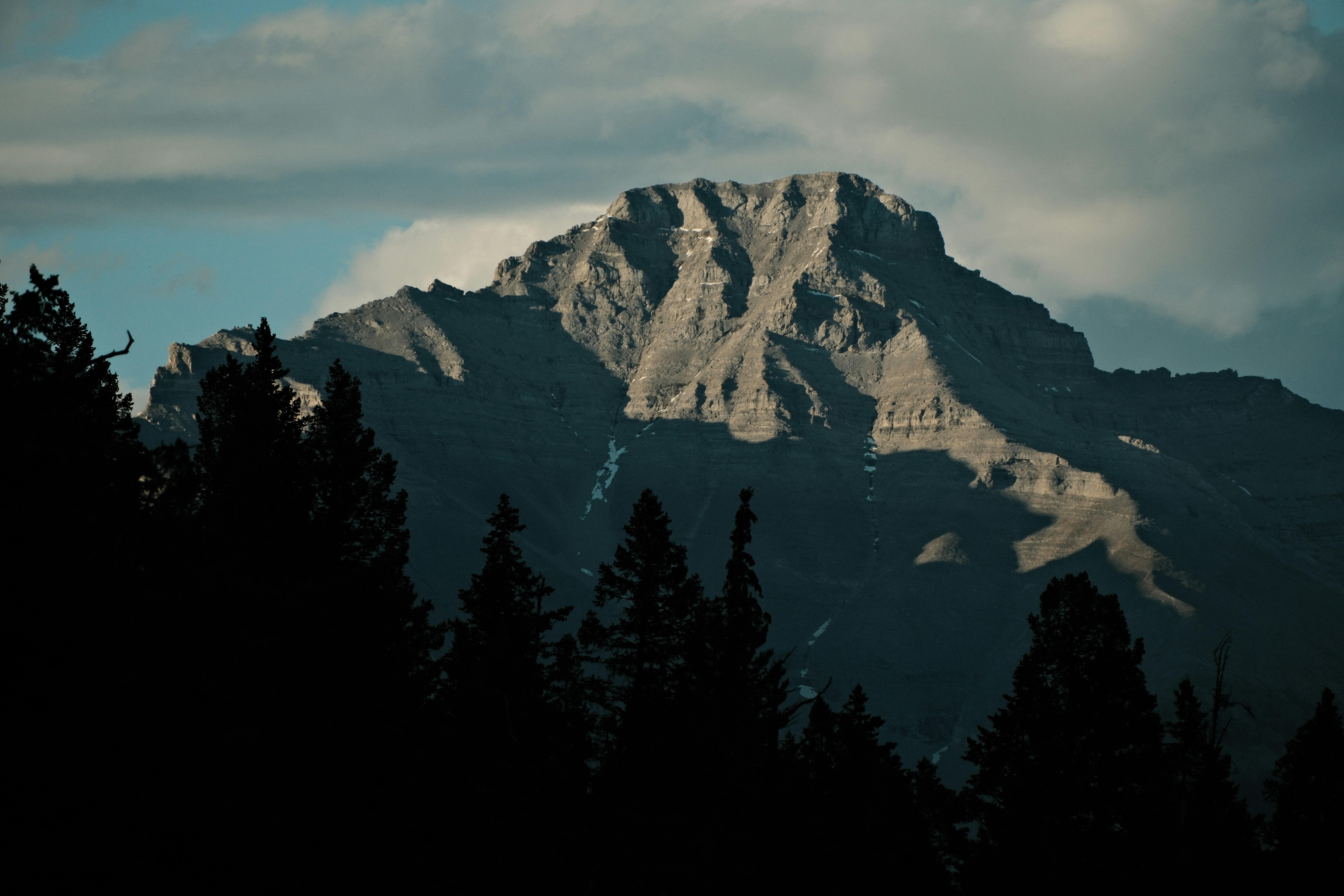 Dawn Light Cascades Across a Rugged Summit