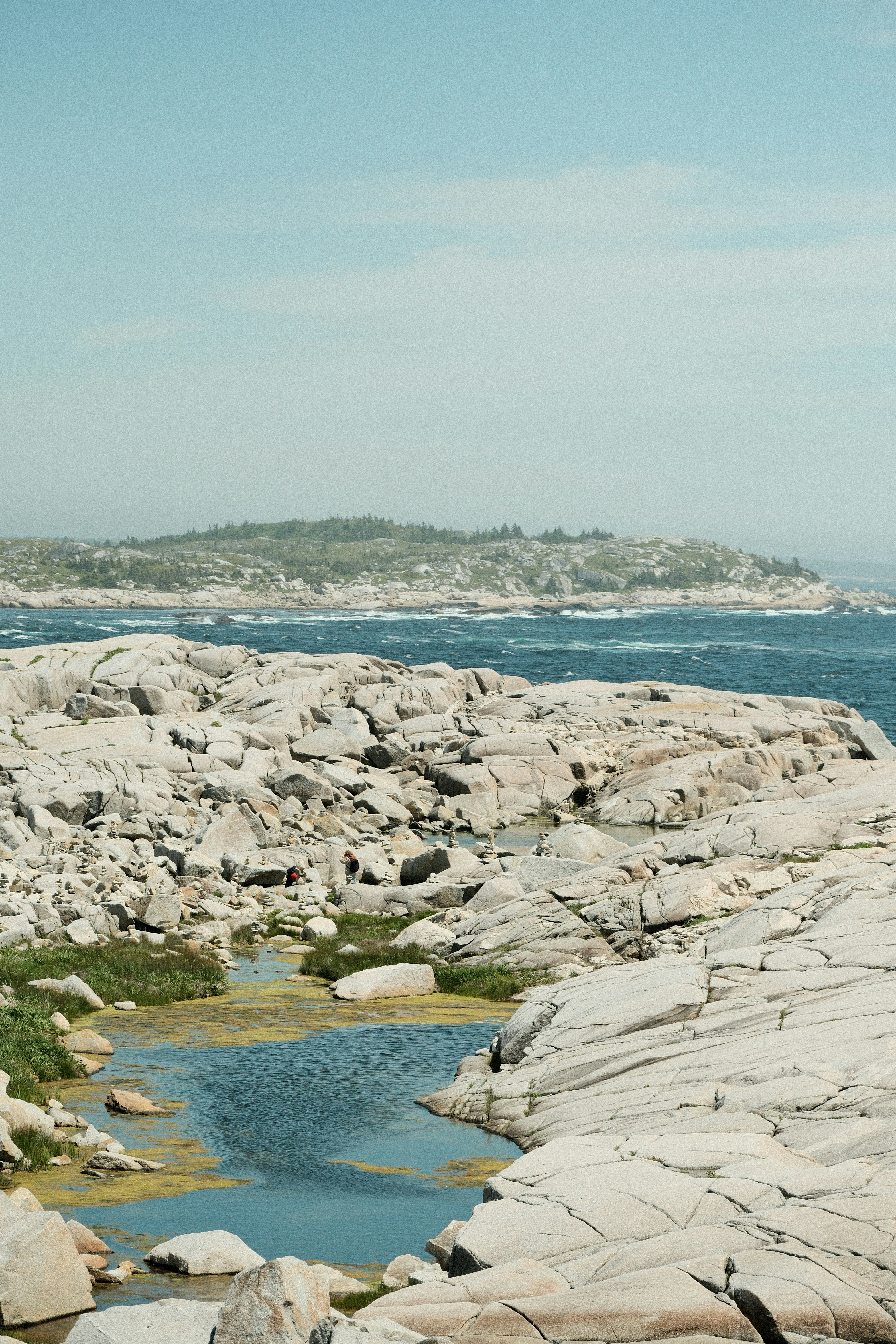 Coastal Granite Tides: A Quiet Tidepool Amidst Wind-Swept Rocks