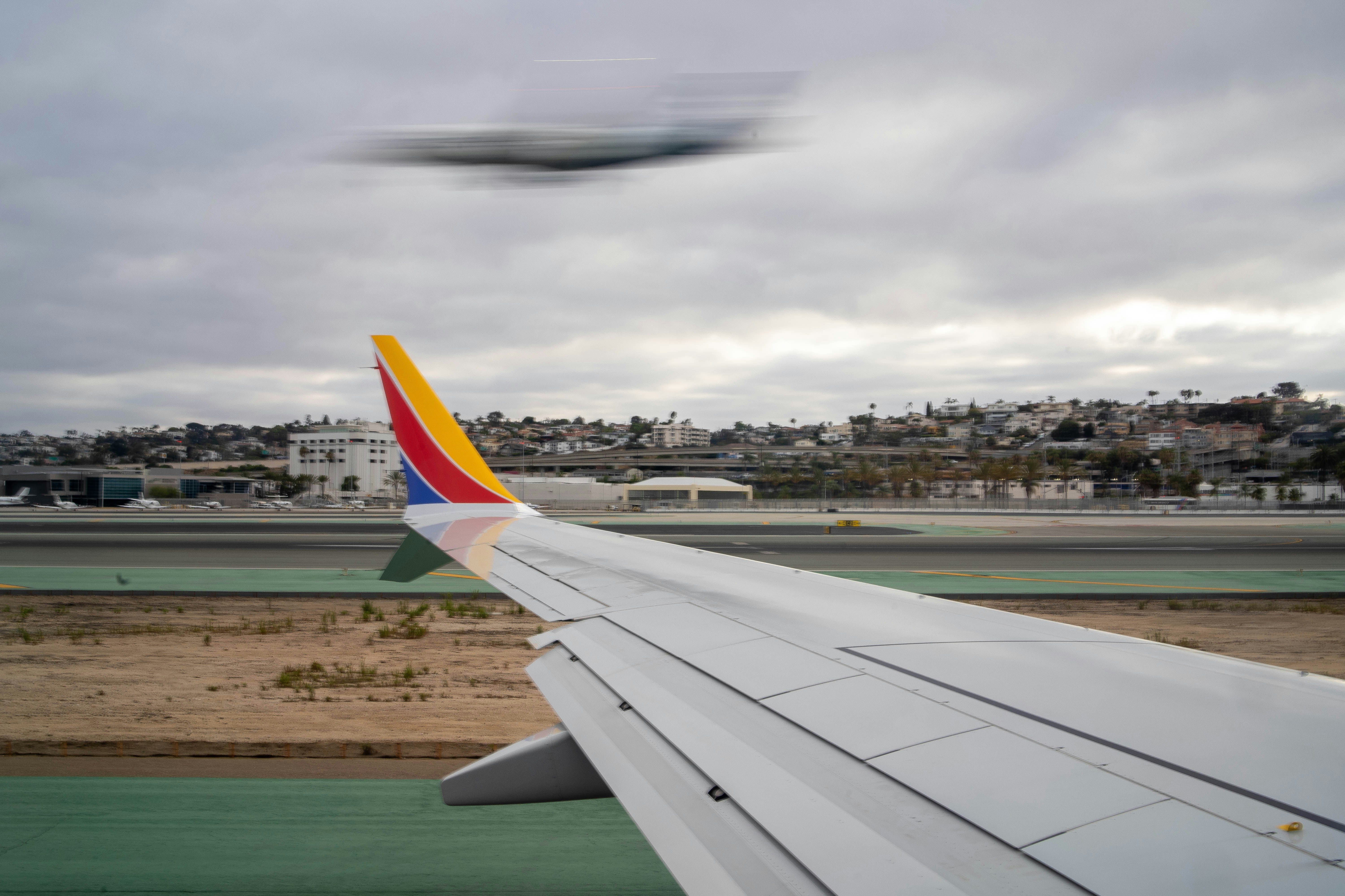 Wing Tip Vanishing Point: A Jet Lifts Off Over a Quiet Tarmac