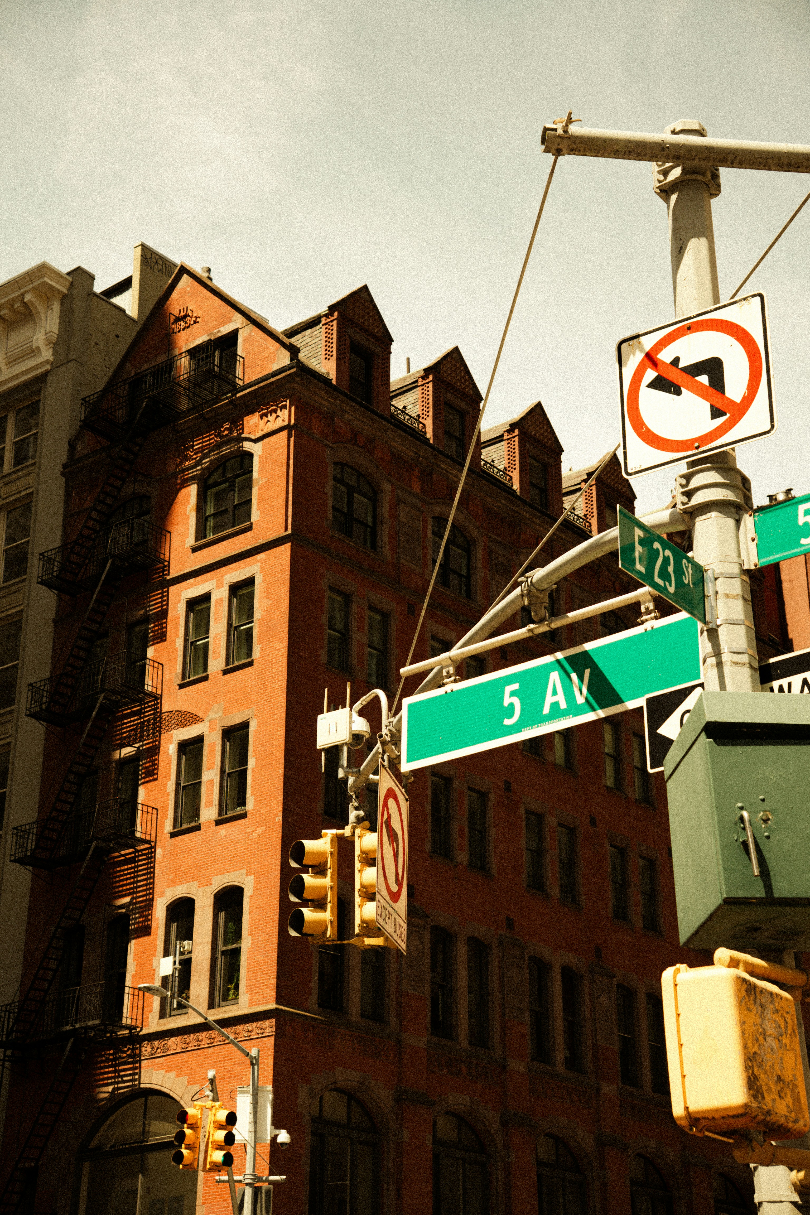 Street Corner Geometry: Brick facade meets green avenue sign