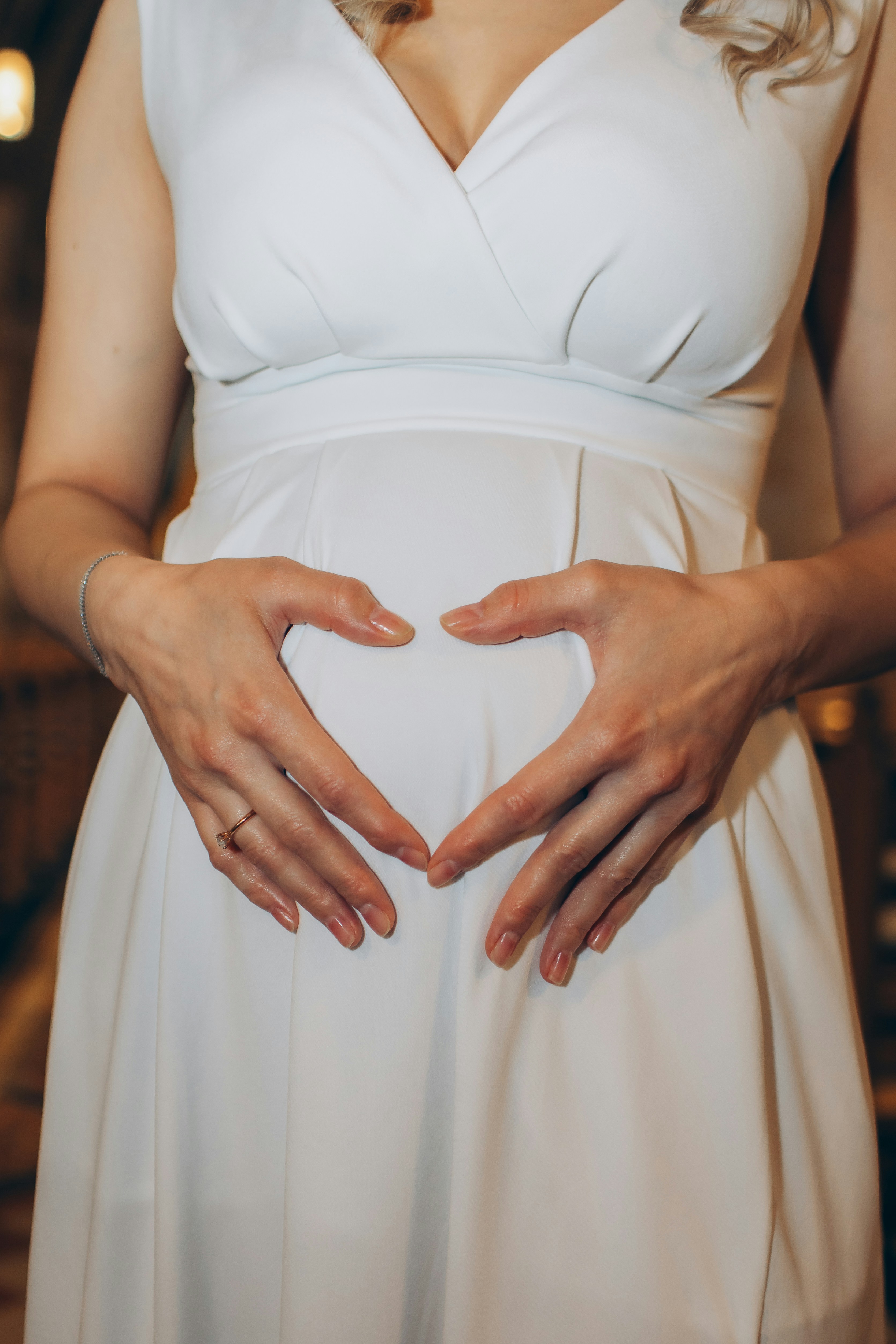 Gentle Embrace: A Pregnant Silhouette Forming a Heart