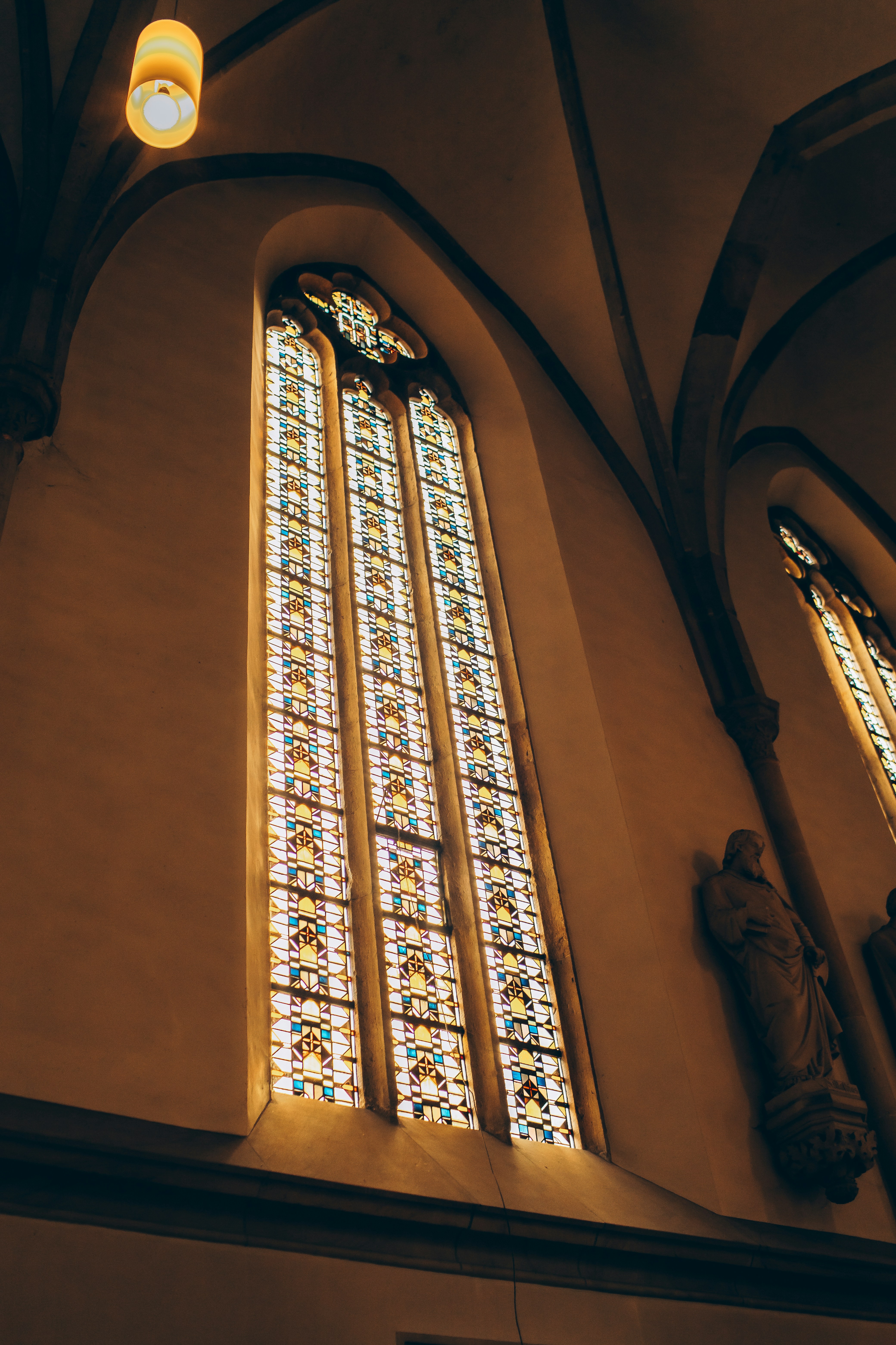 Stained Glass Quiet: A Cathedral Window Soaks in Warm Light