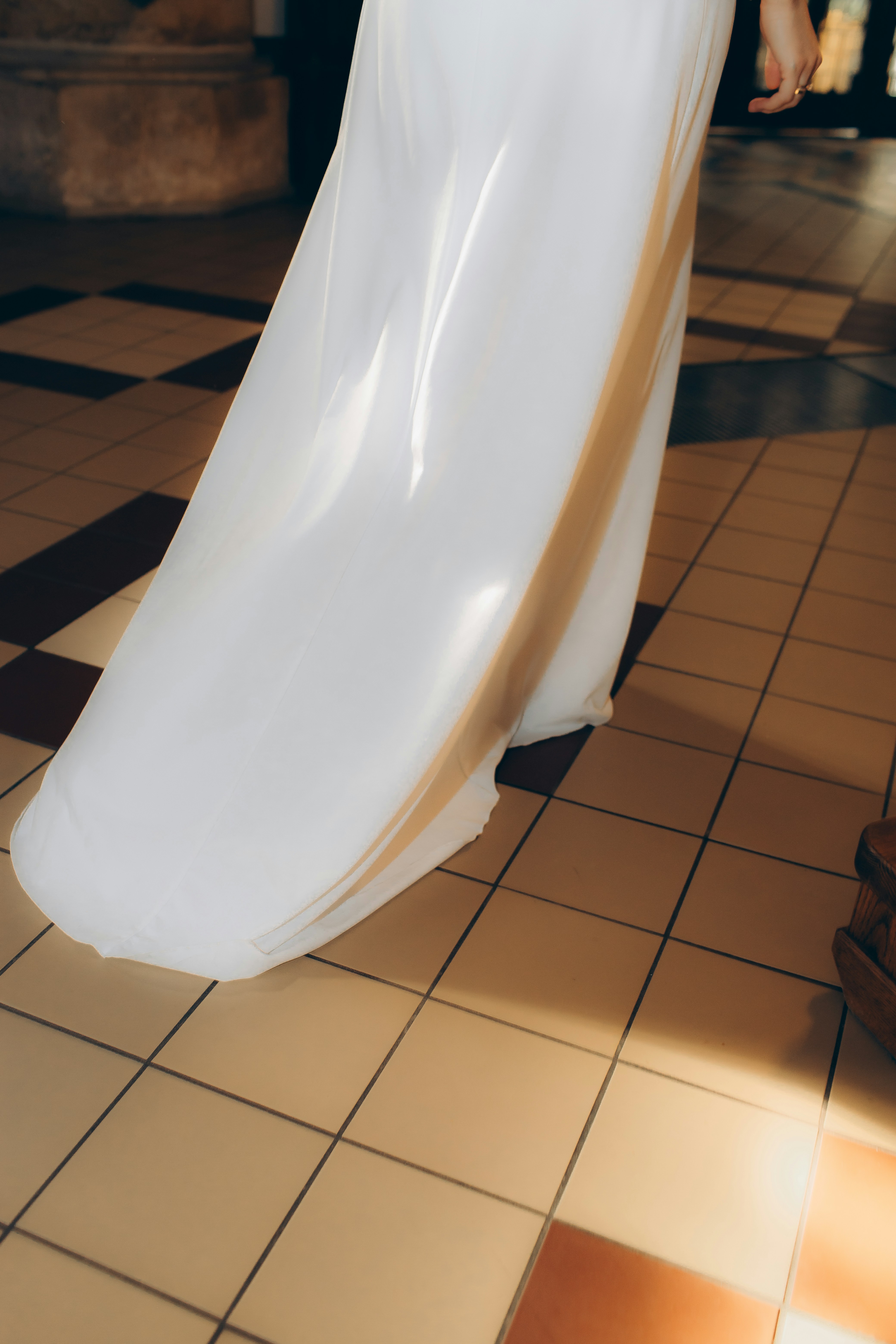 A Velvet Float: Draped White Gown Along a Checkered Floor