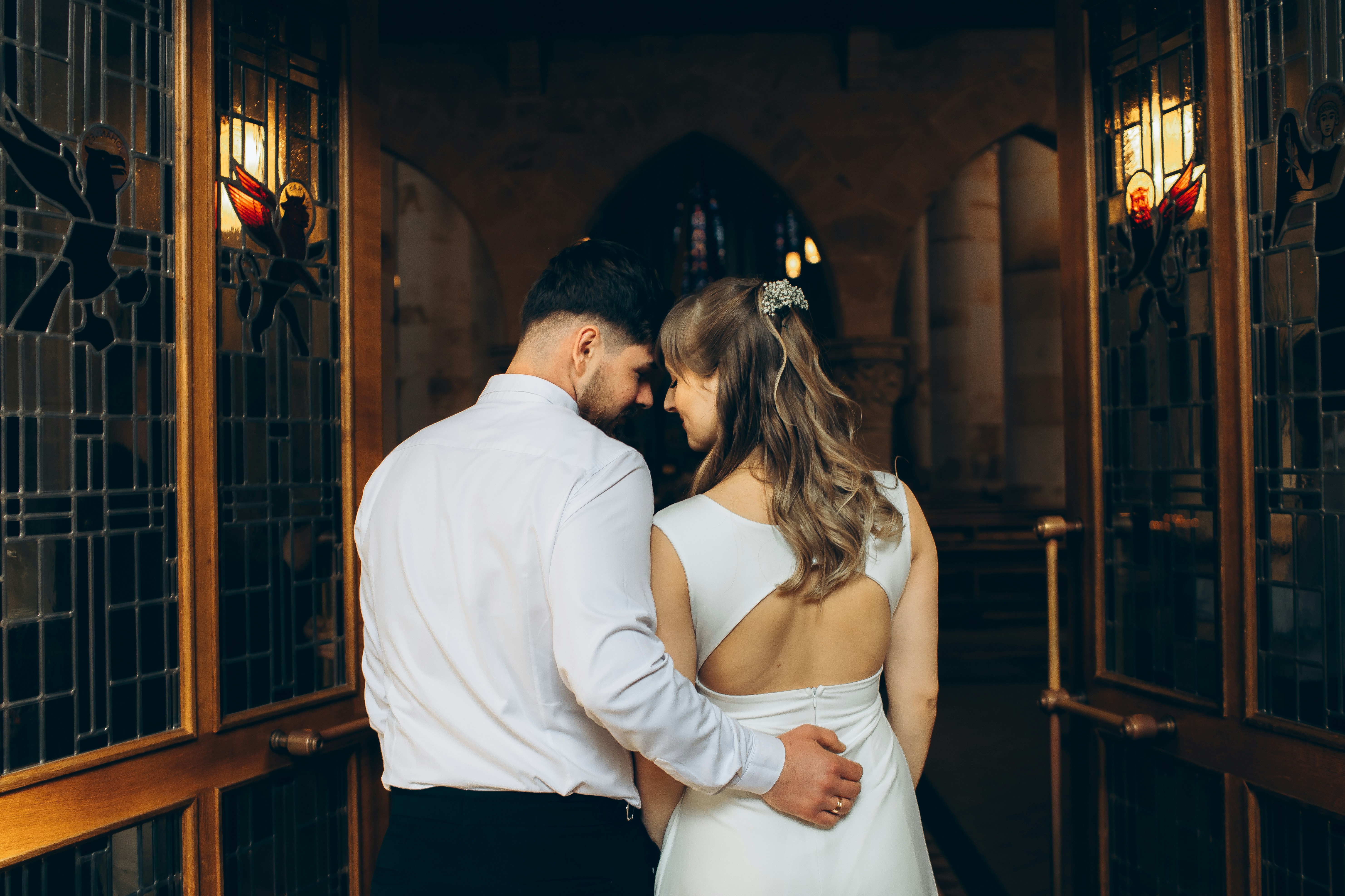 Veil of Quiet: A Bride and Groom in a Cathedral Corridor