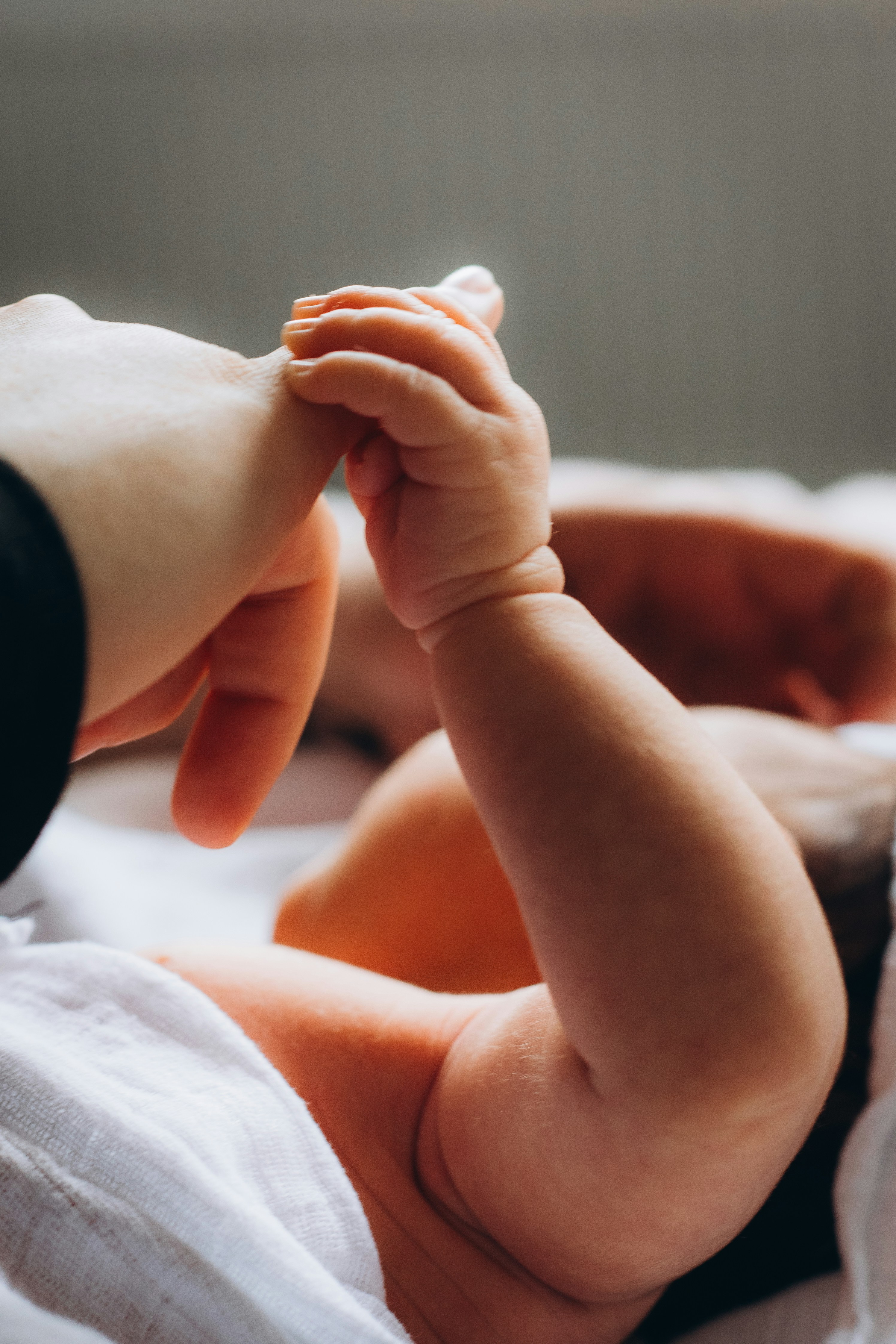 Holding On: The Gentle Hold Between Tiny Hands