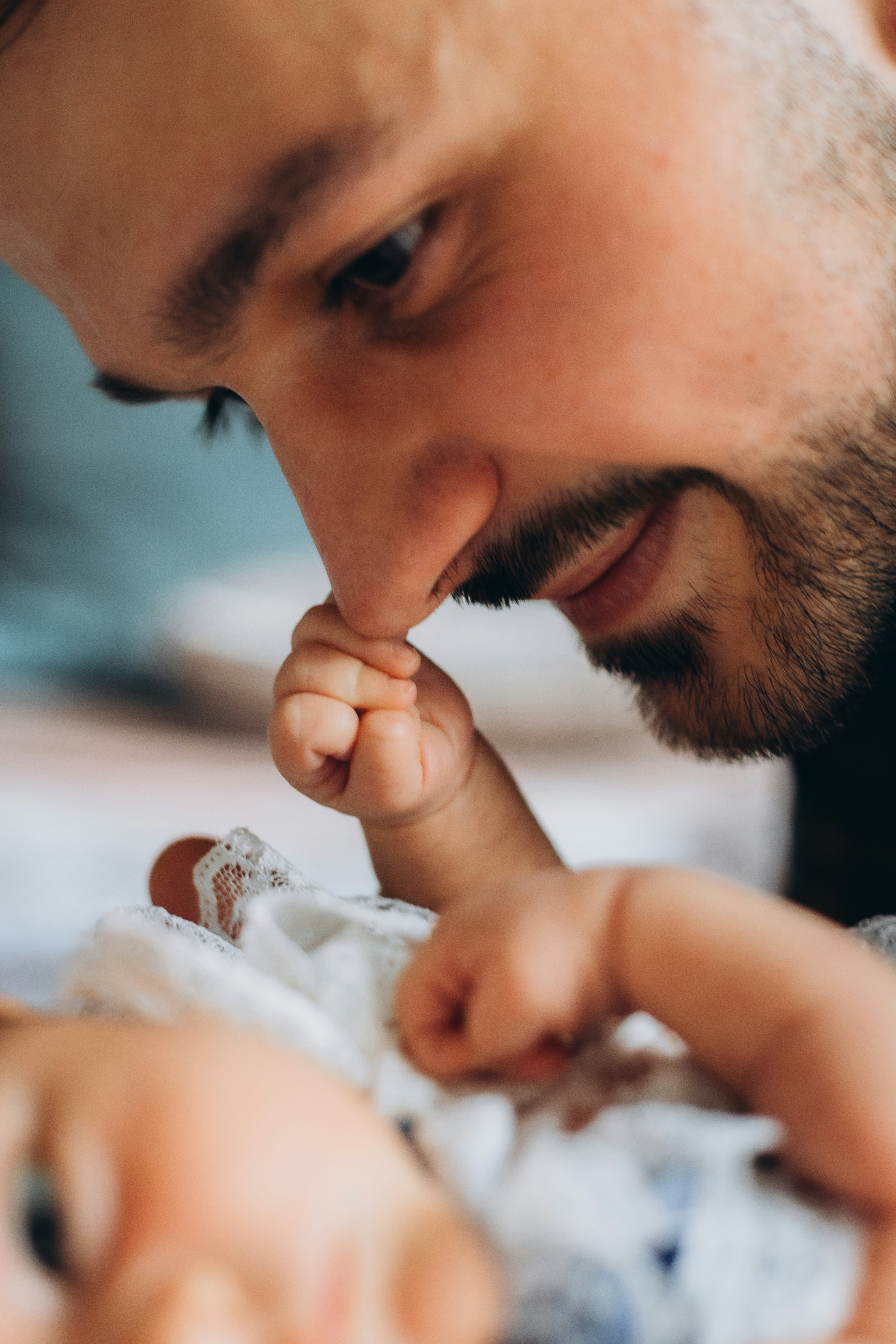 Tender Moment: Father Nuzzles Baby in Soft Focus Portrait