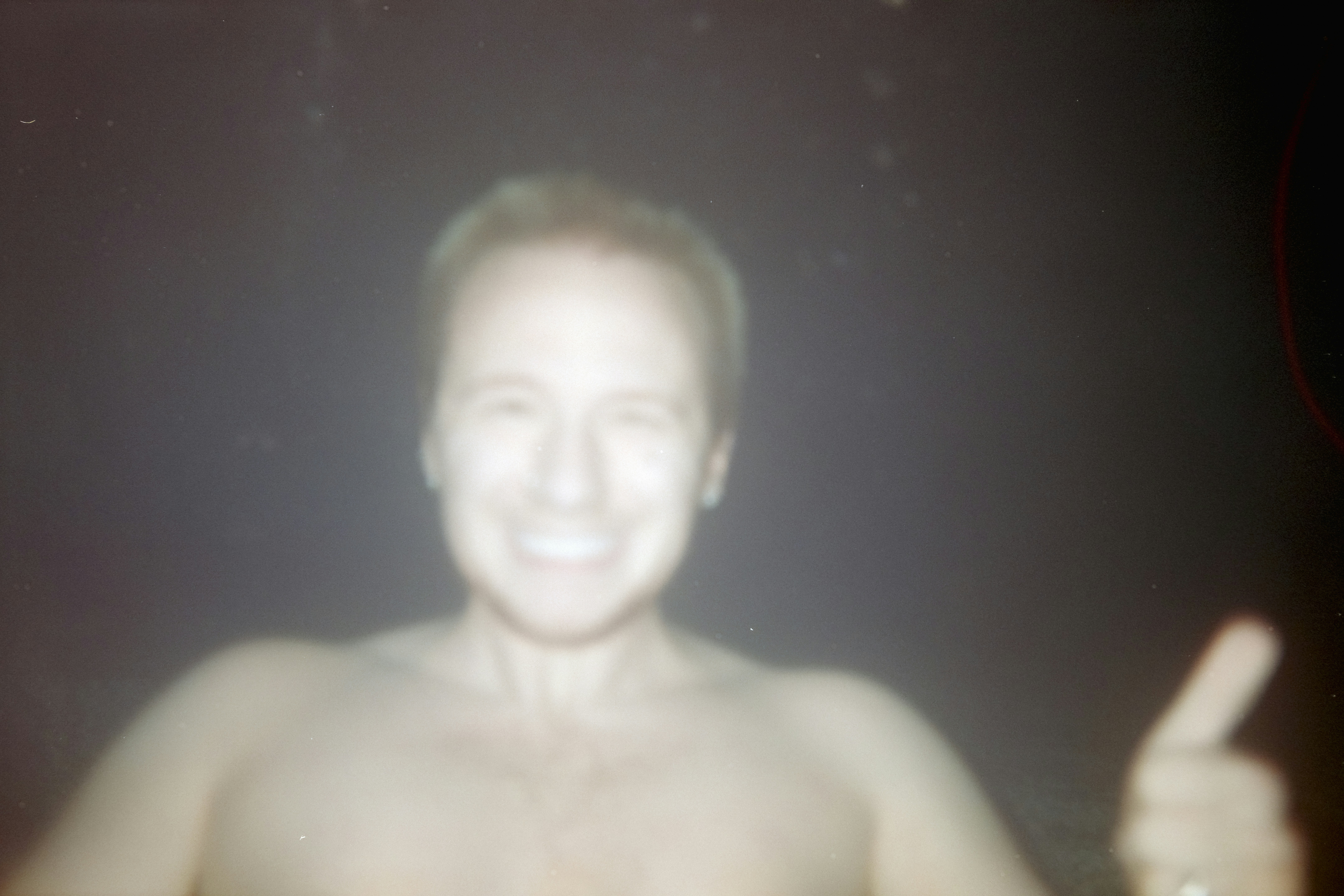 Warm-Glow Grin: A Blurred Selfie at Night