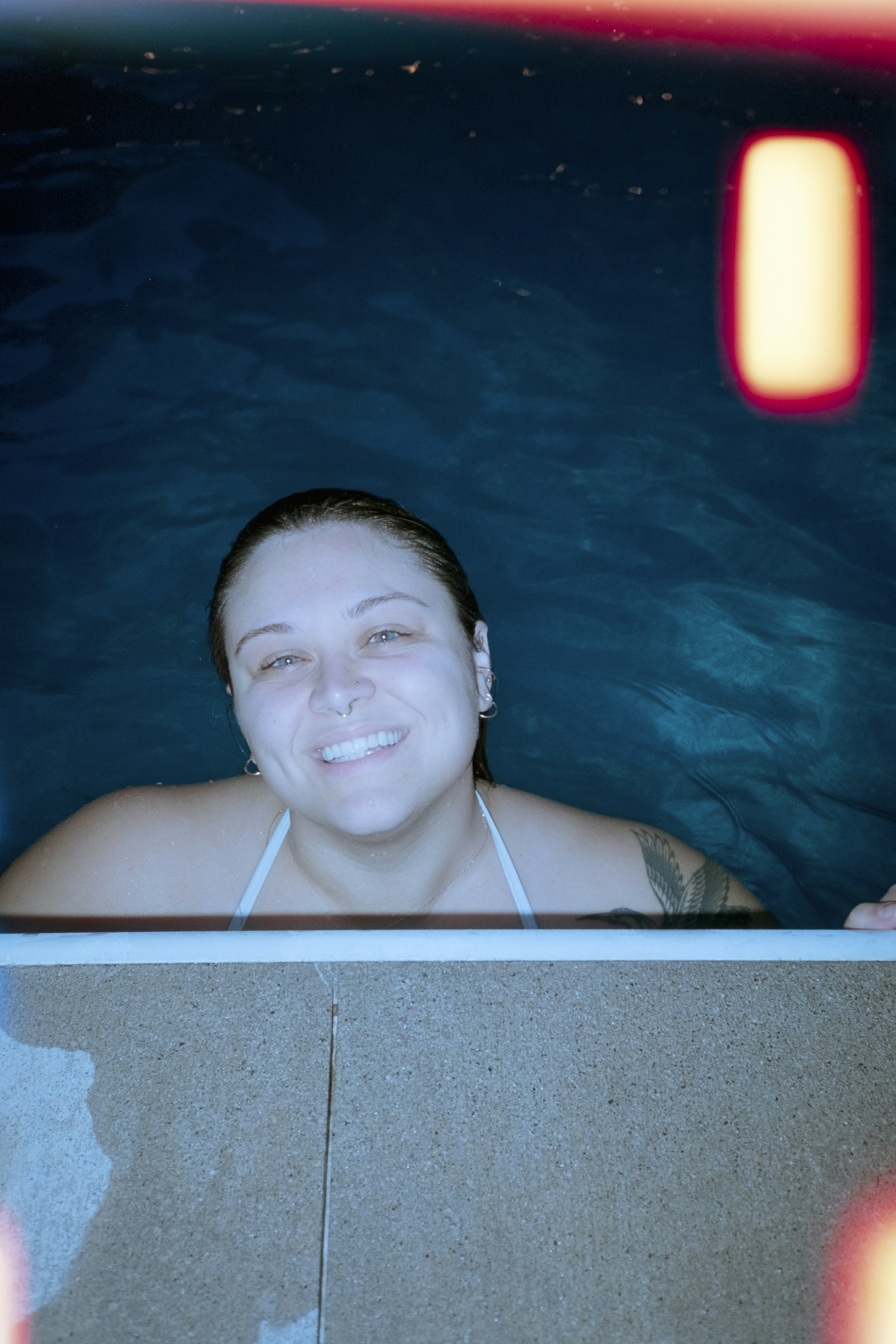 Poolside Portrait: Gentle Smile Above the Tile Rim