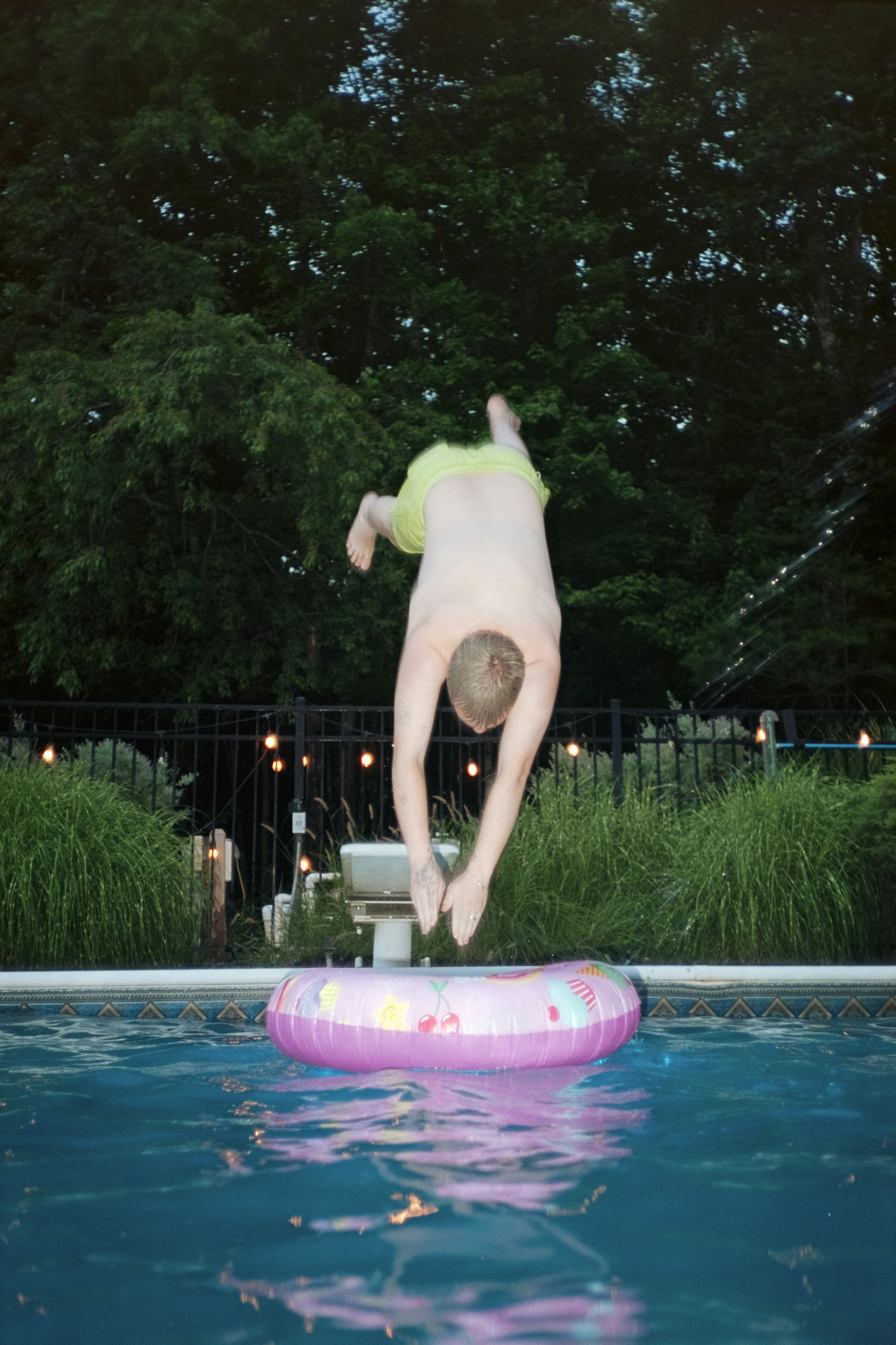 Boy diving into swimming pool above pink inflatable photo – Free Summer ...