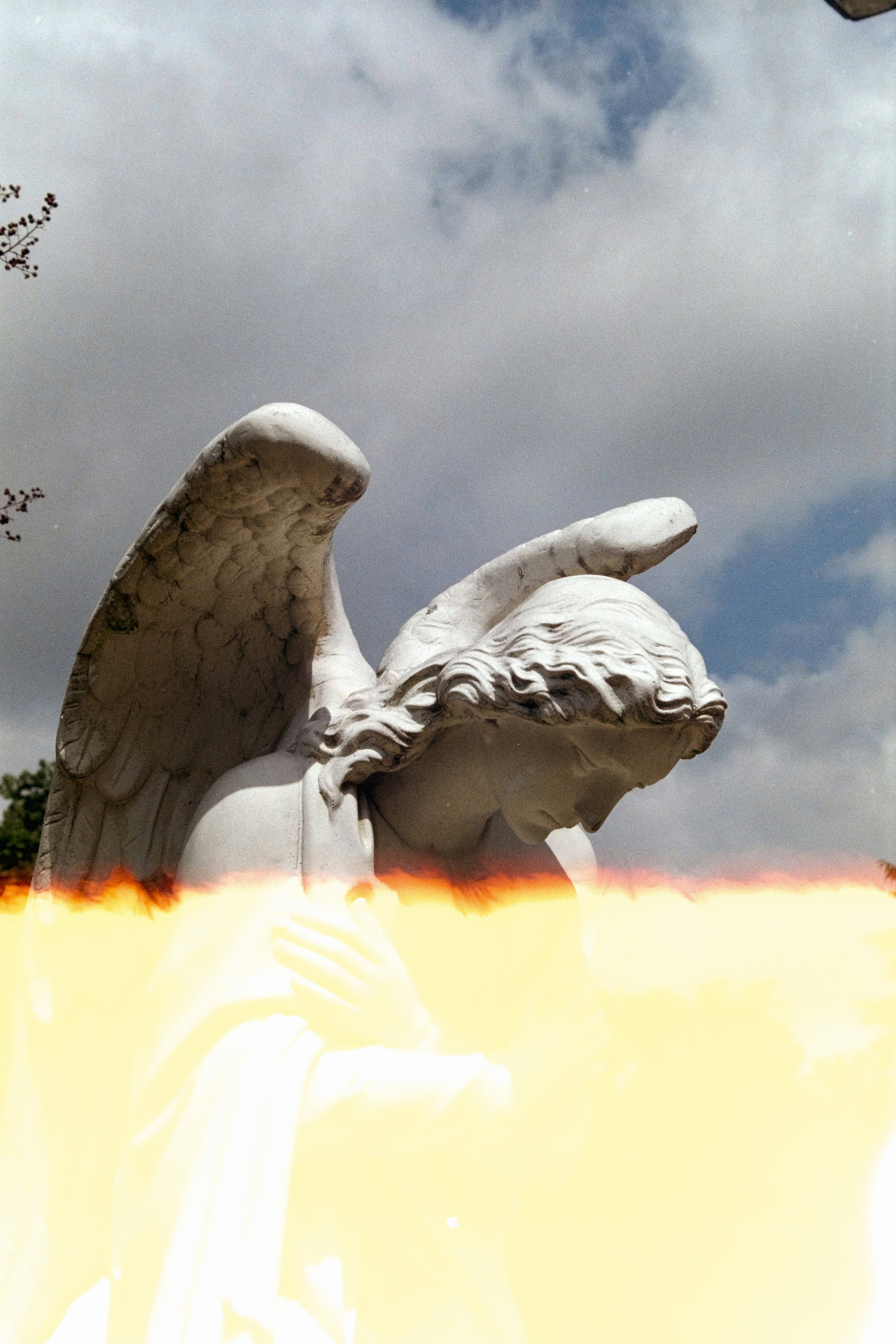 Angel on a pedestal: a stone guardian beneath a skyward gaze
