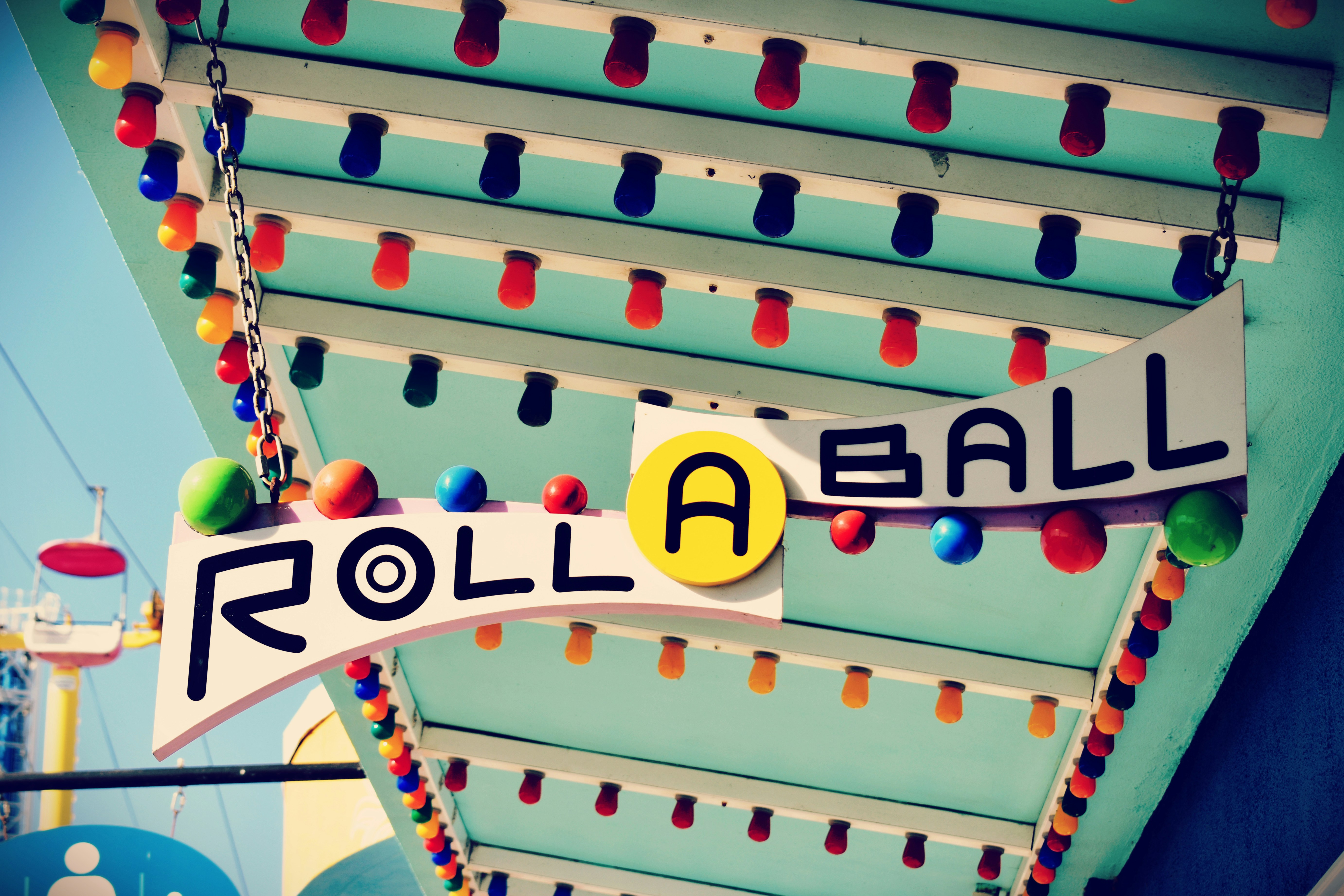 Neon Sign Glow: Roll-A-Ball Entrance Under Colorful Bulbs