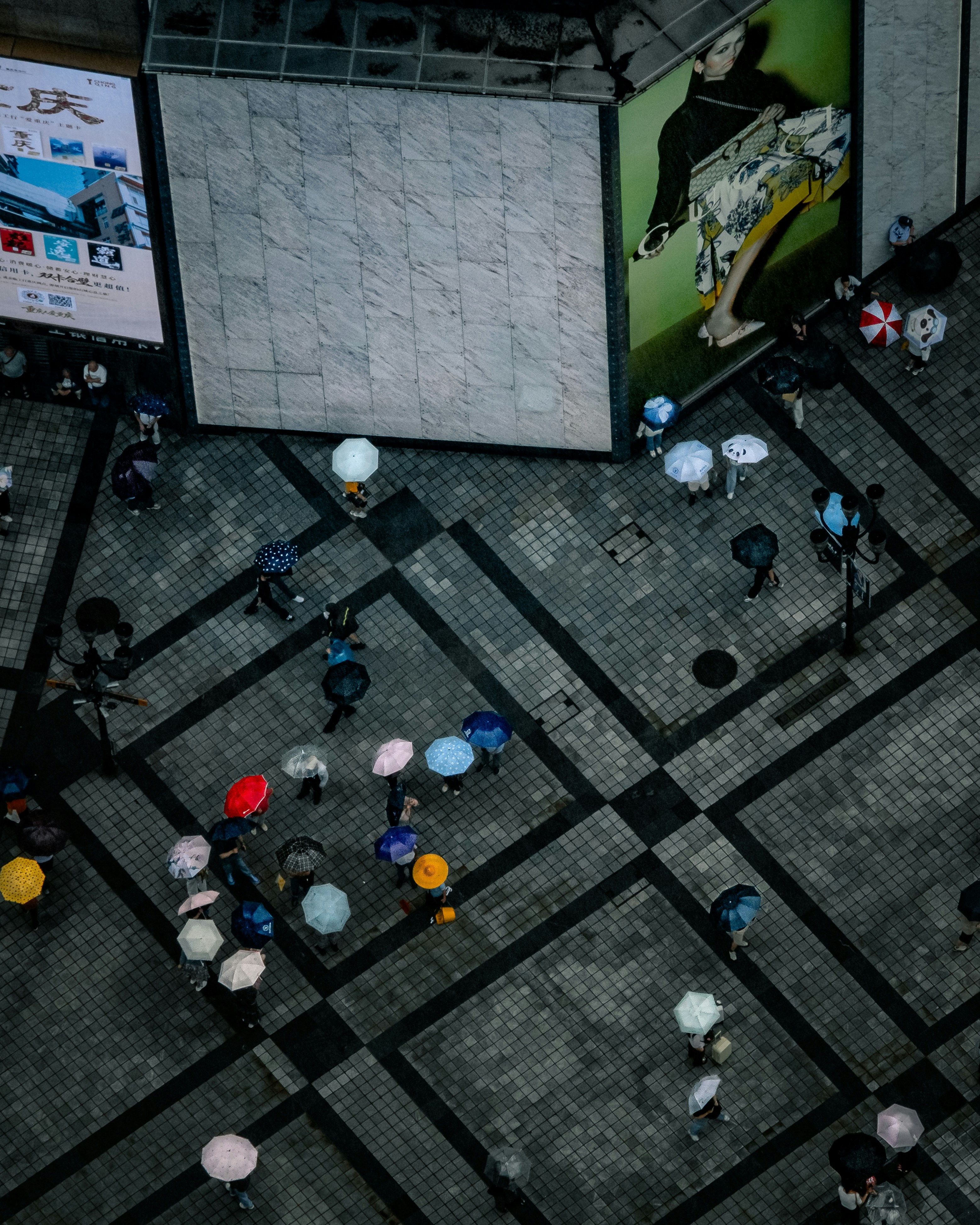 Umbrella Mosaic: Aerial View of Pedestrian Pattern in a Rainy Plaza