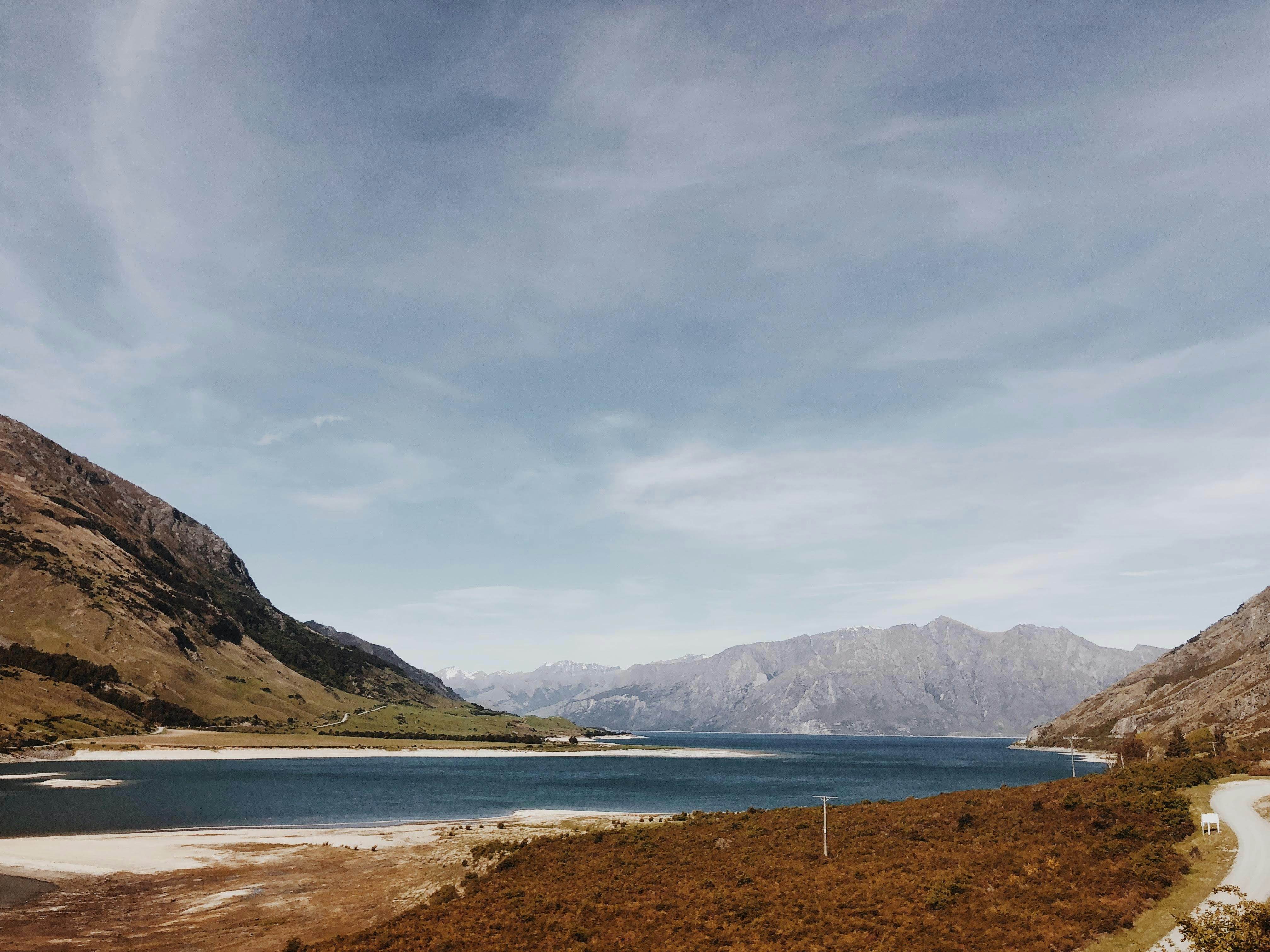 Vast Alpine Basin Meeting a Serene Fjord under Clear Sky