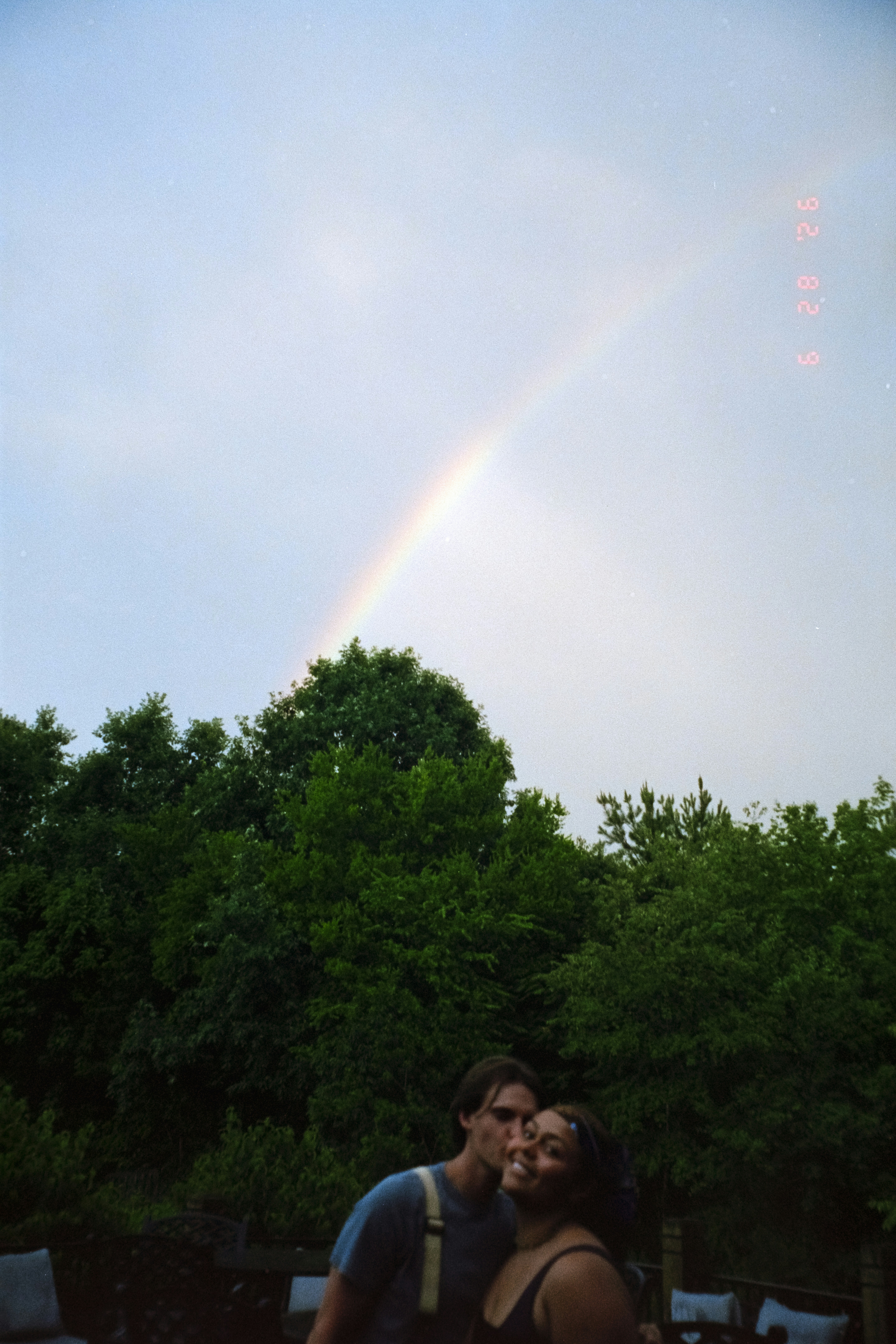 Rainbow Over Quiet Twilight: Lovers Beneath Green Canopy
