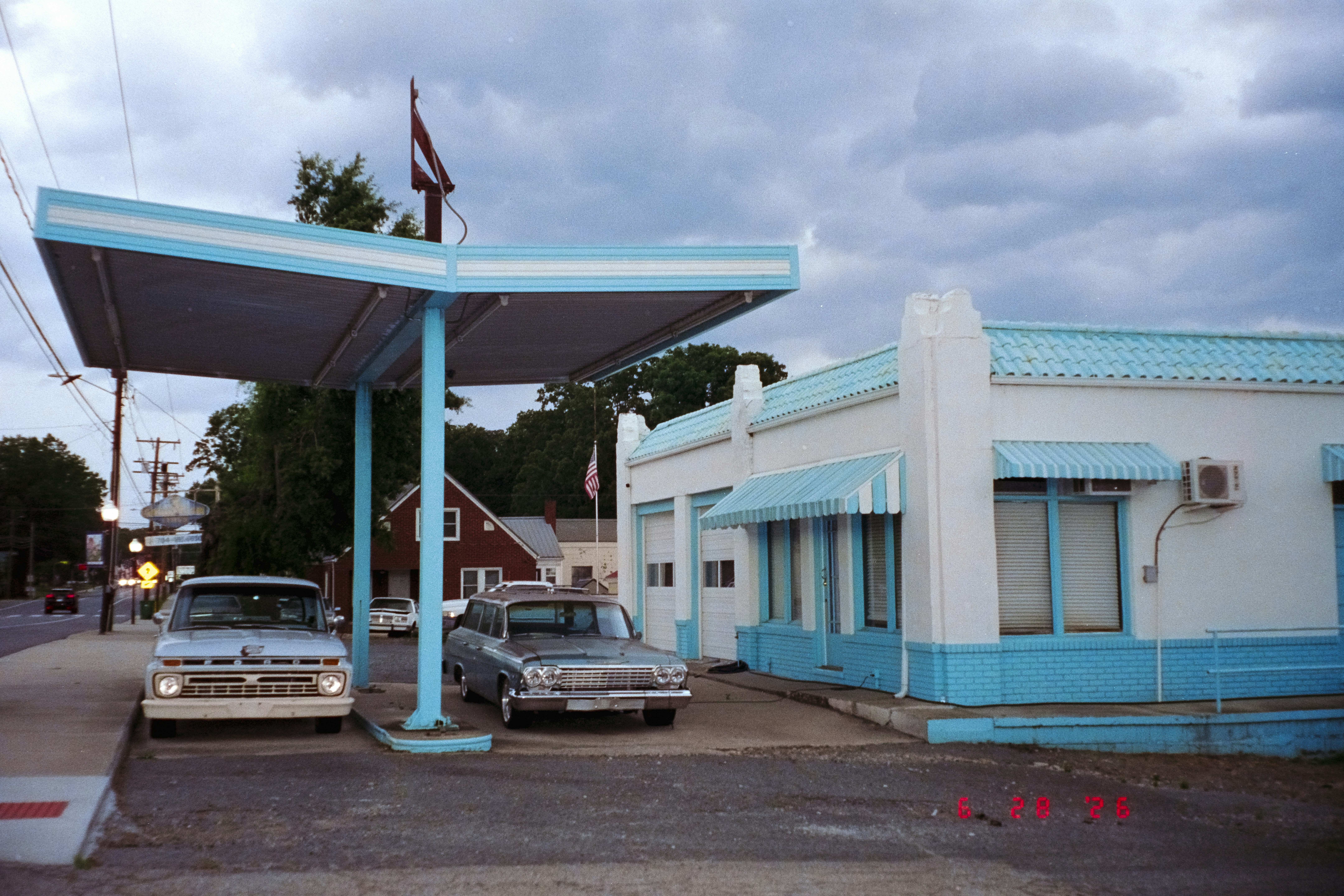 Midcentury Neon Diner: Cars Under a Turquoise Canopy