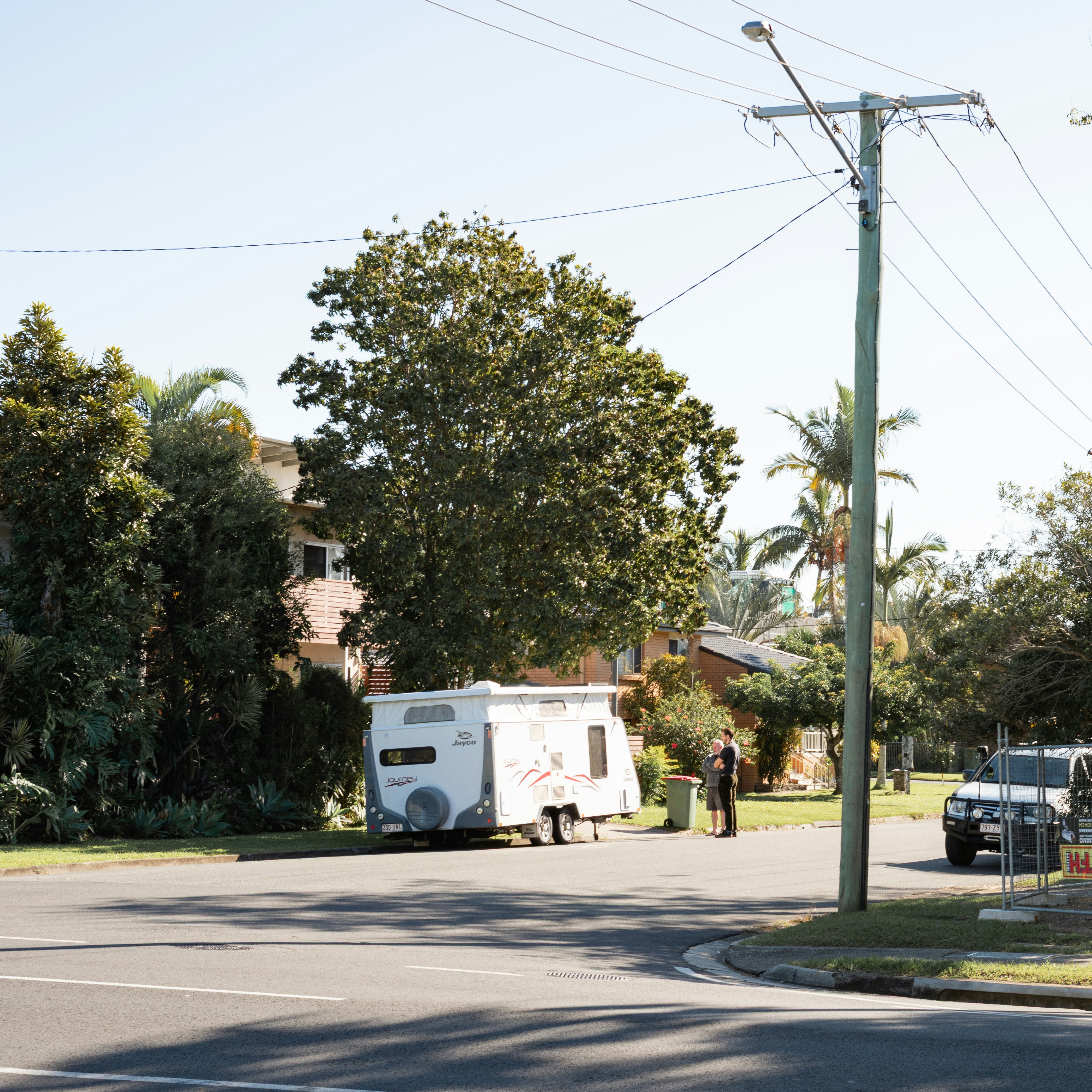 Quiet Suburban Street Scene with Camper Van and Palm Trees