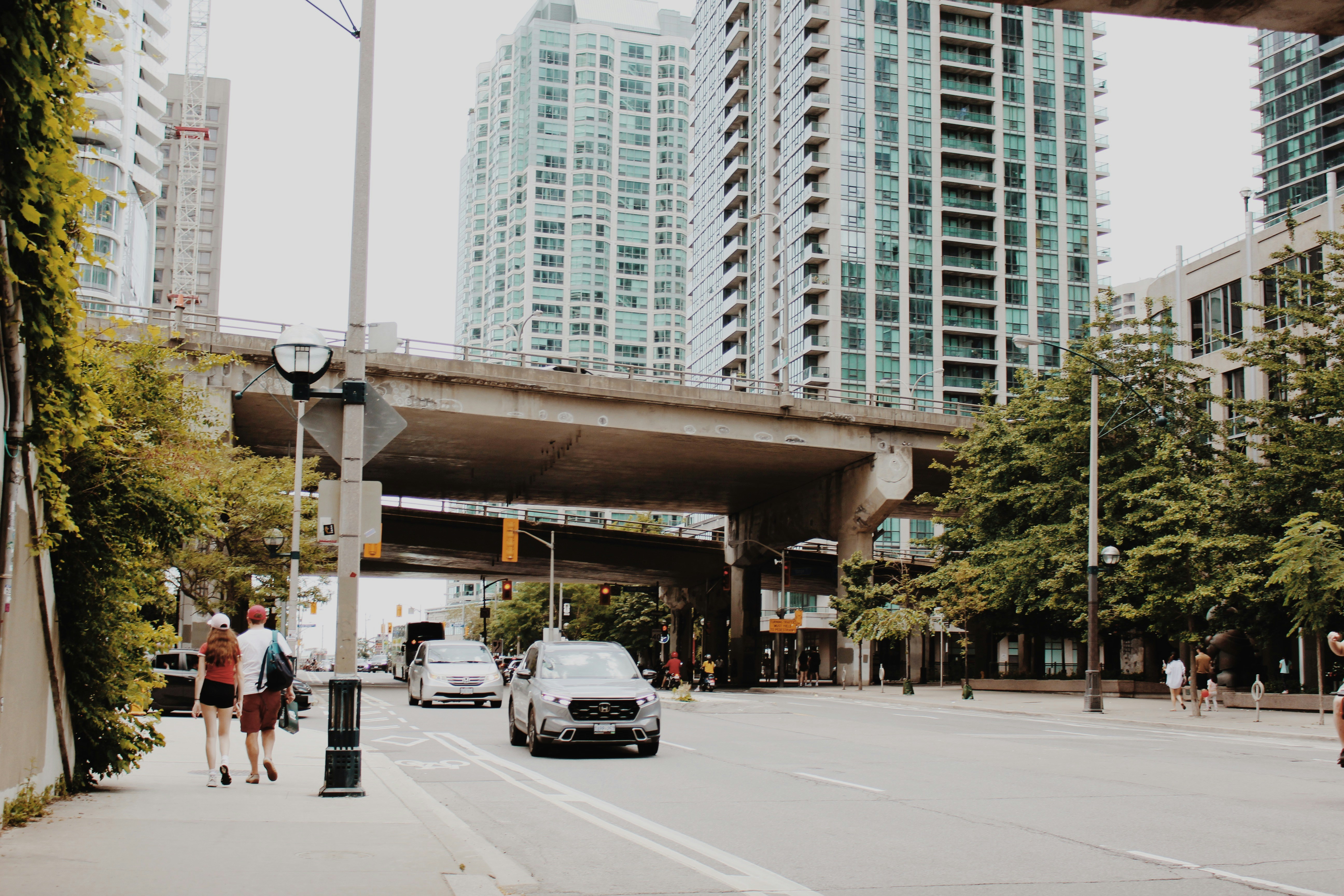 City Arterial: Cars, Pedestrians, and a Lofty Overpass